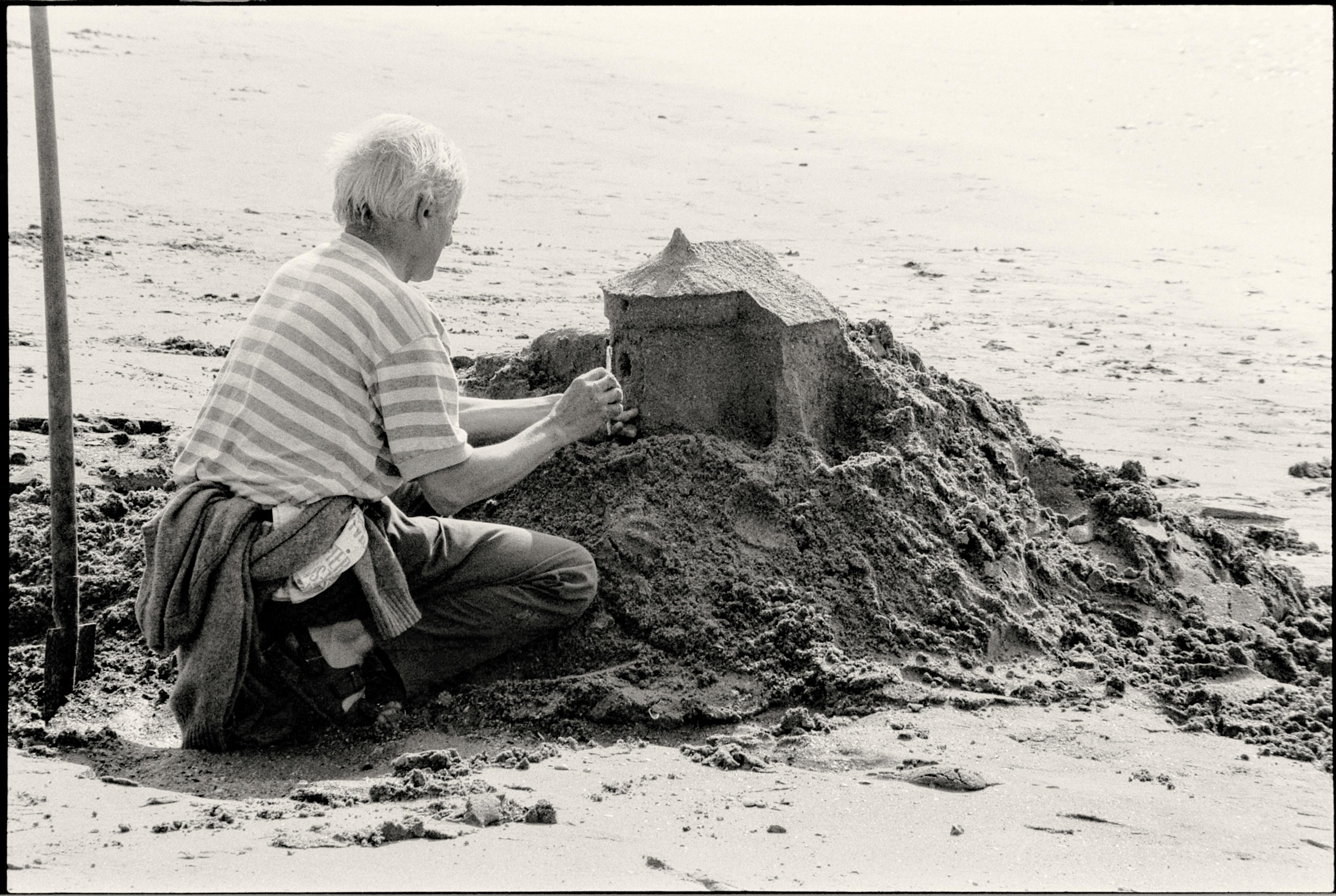 Man Building Sand Castle · Free Stock Photo