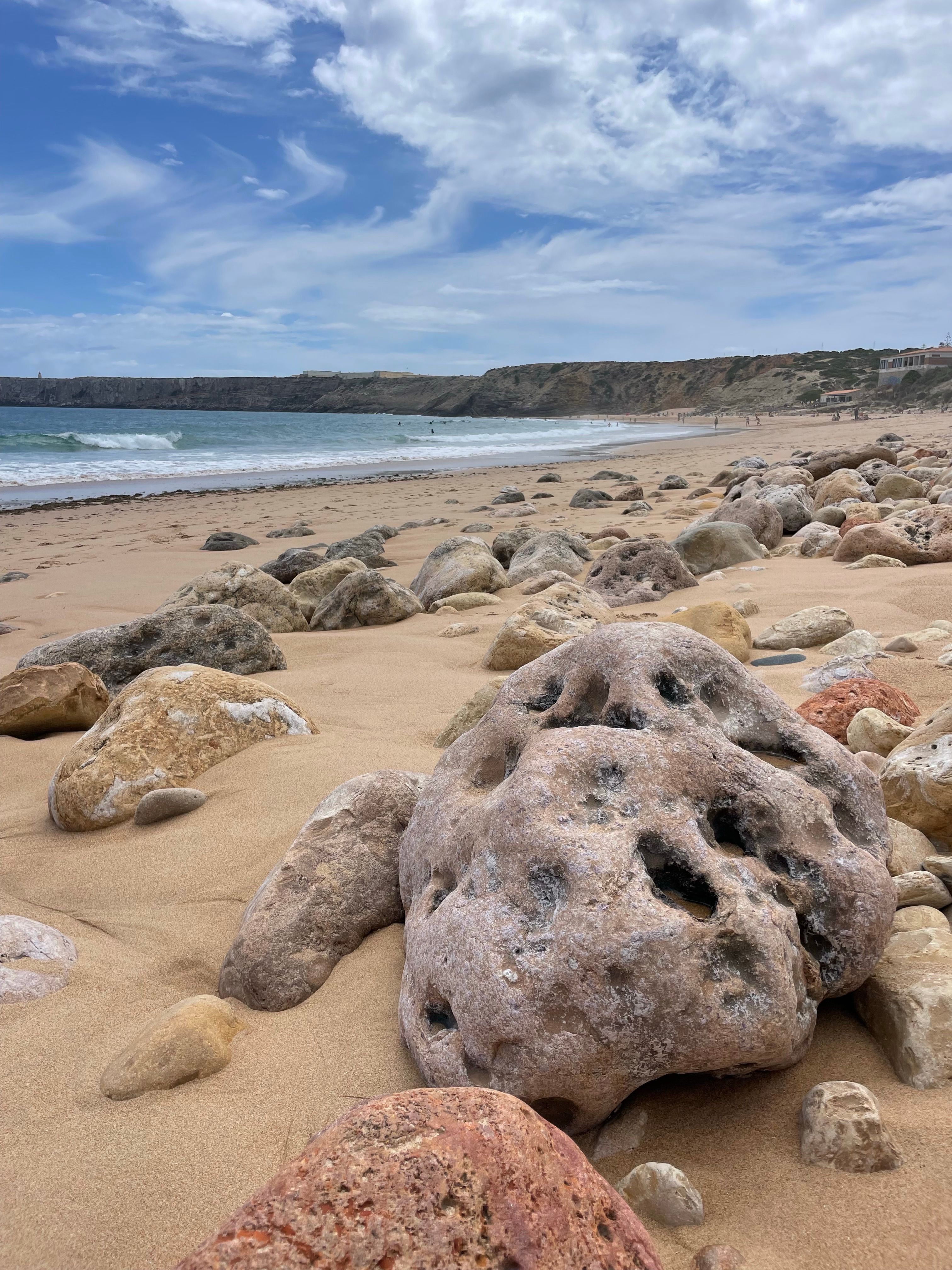 View of a Rocky Beach and Cliffs in the Background · Free Stock Photo