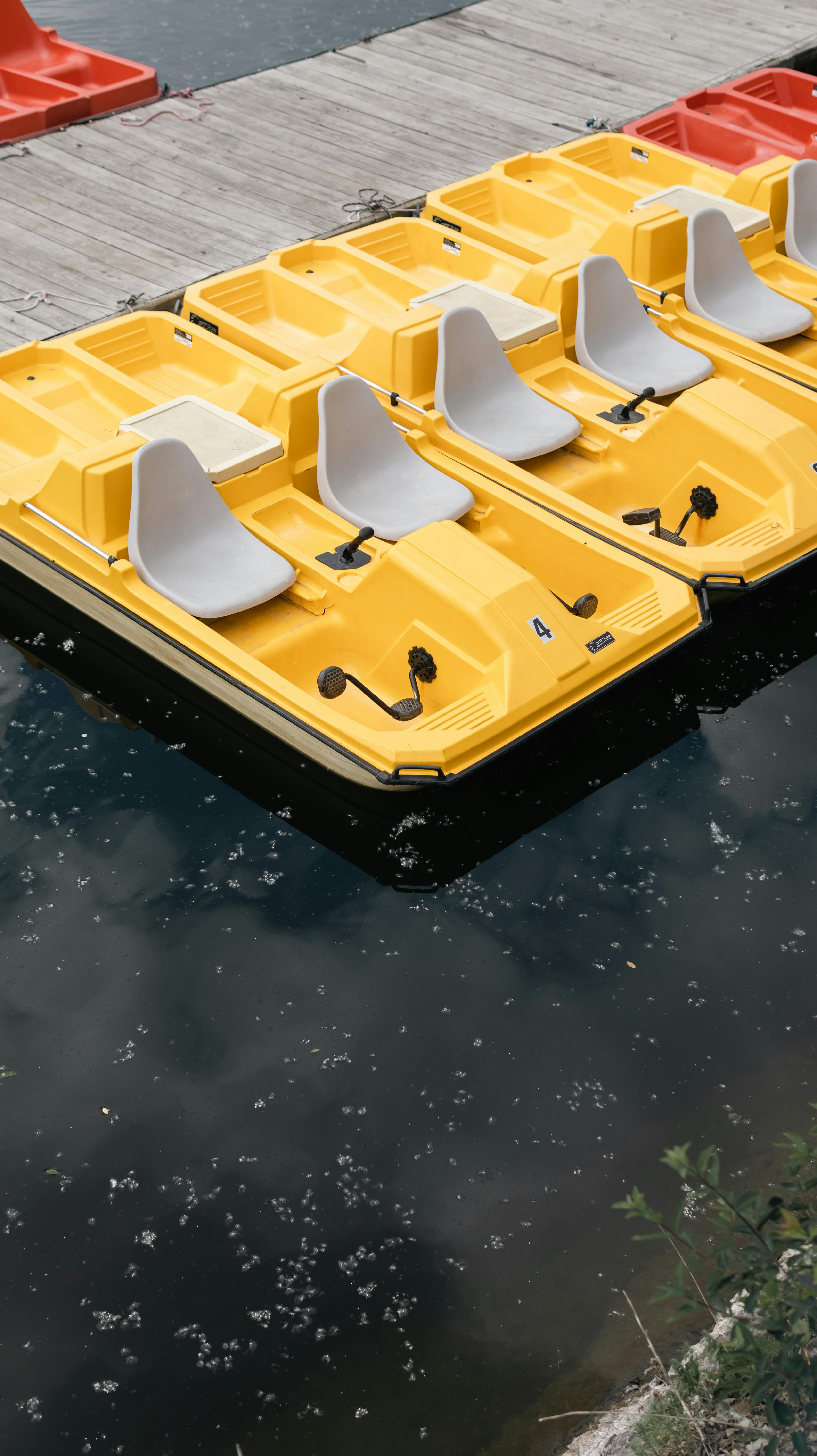 Yellow Plastic Boats Moored on a Pond · Free Stock Photo