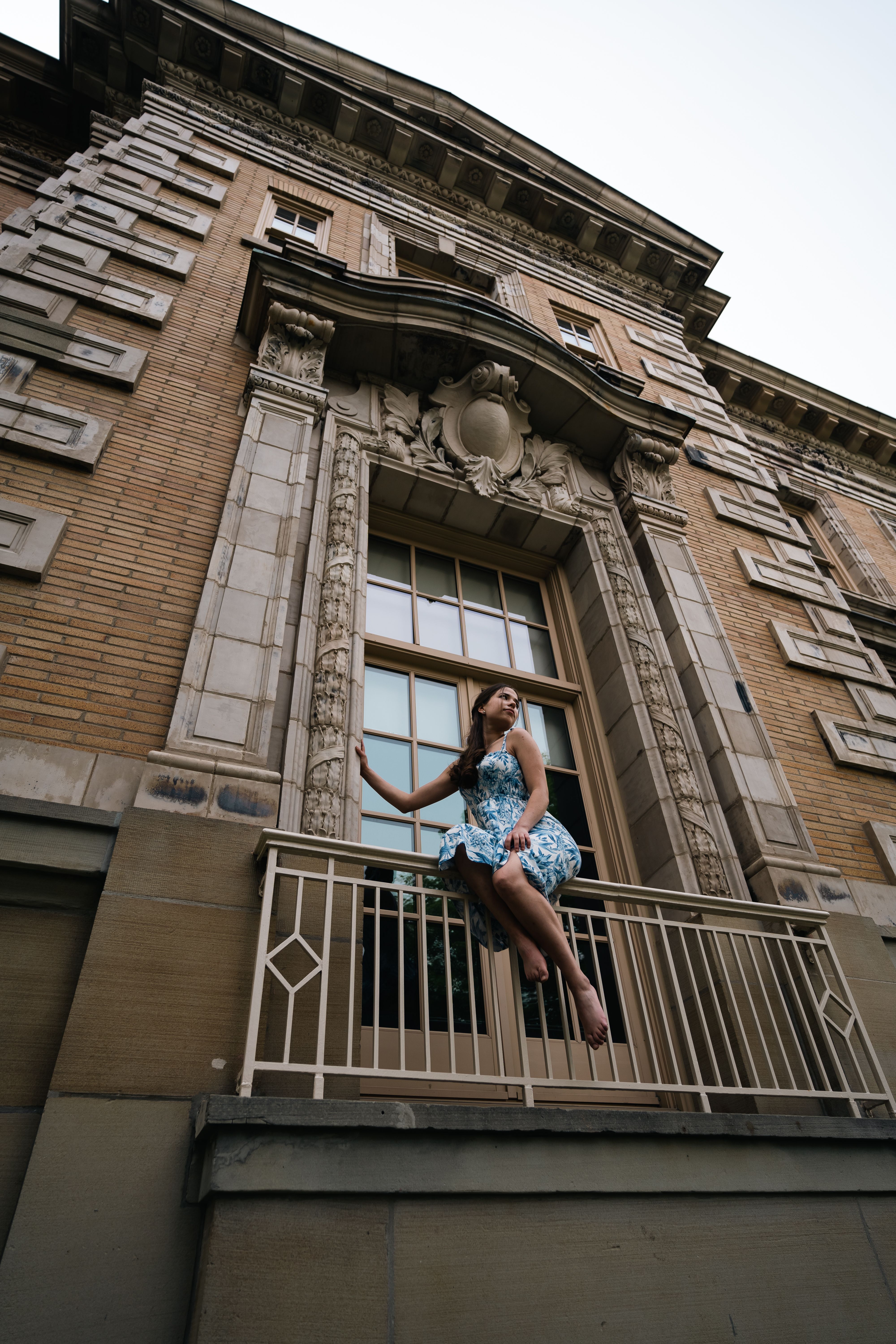 Woman Posing on Building Railing · Free Stock Photo