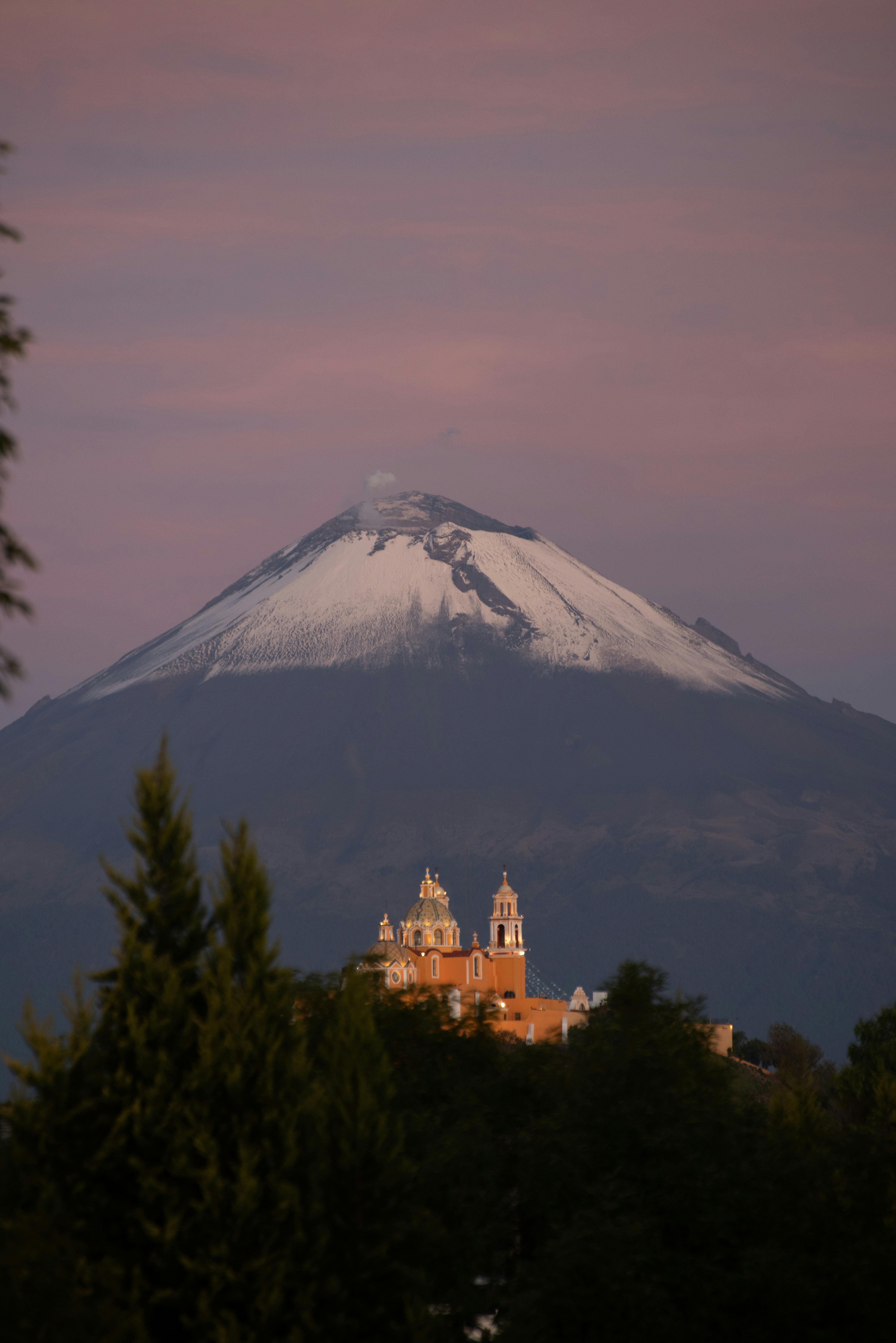 Snow on Volcano Mountain over Abbey in Forest · Free Stock Photo