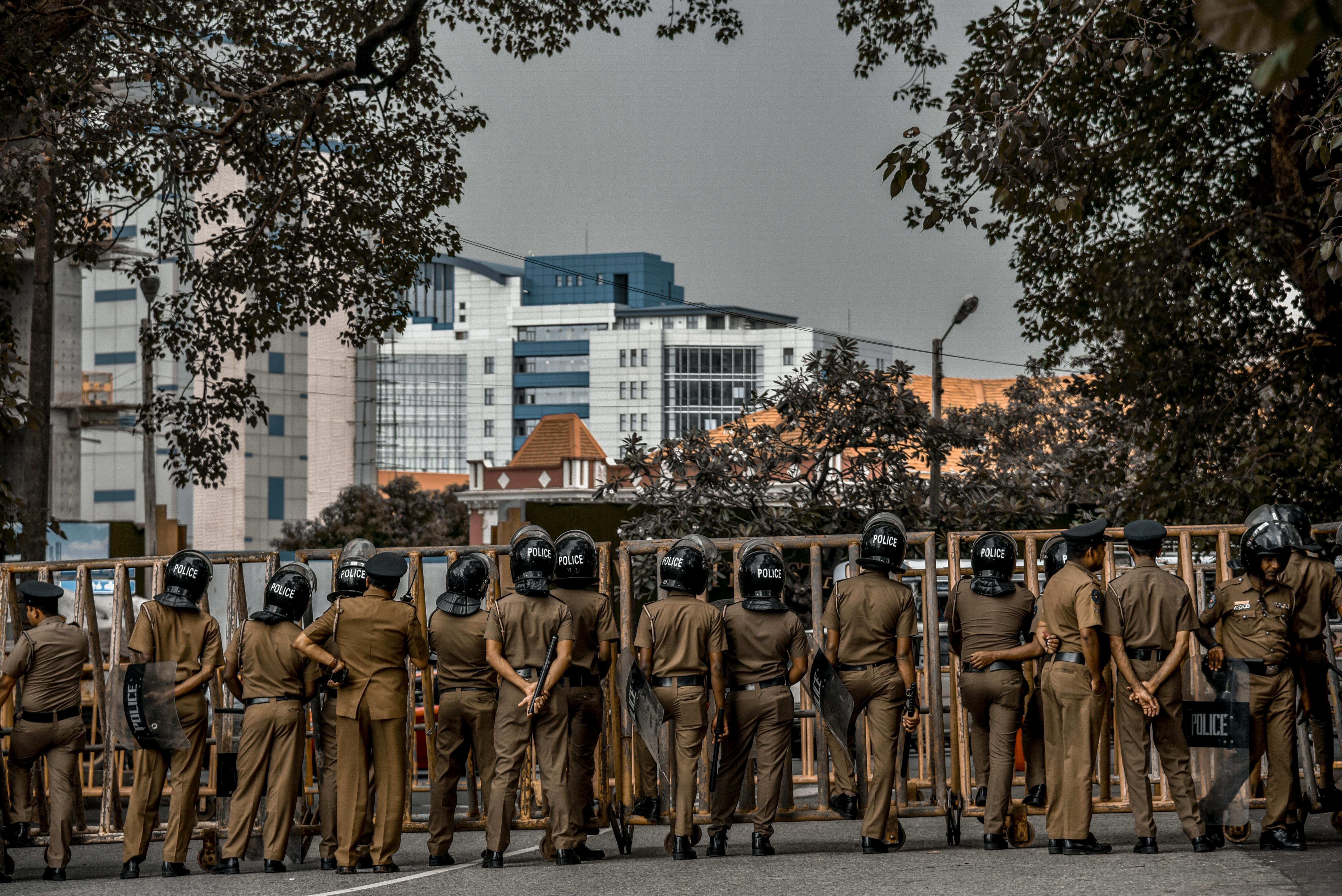 Police Standing On Road · Free Stock Photo