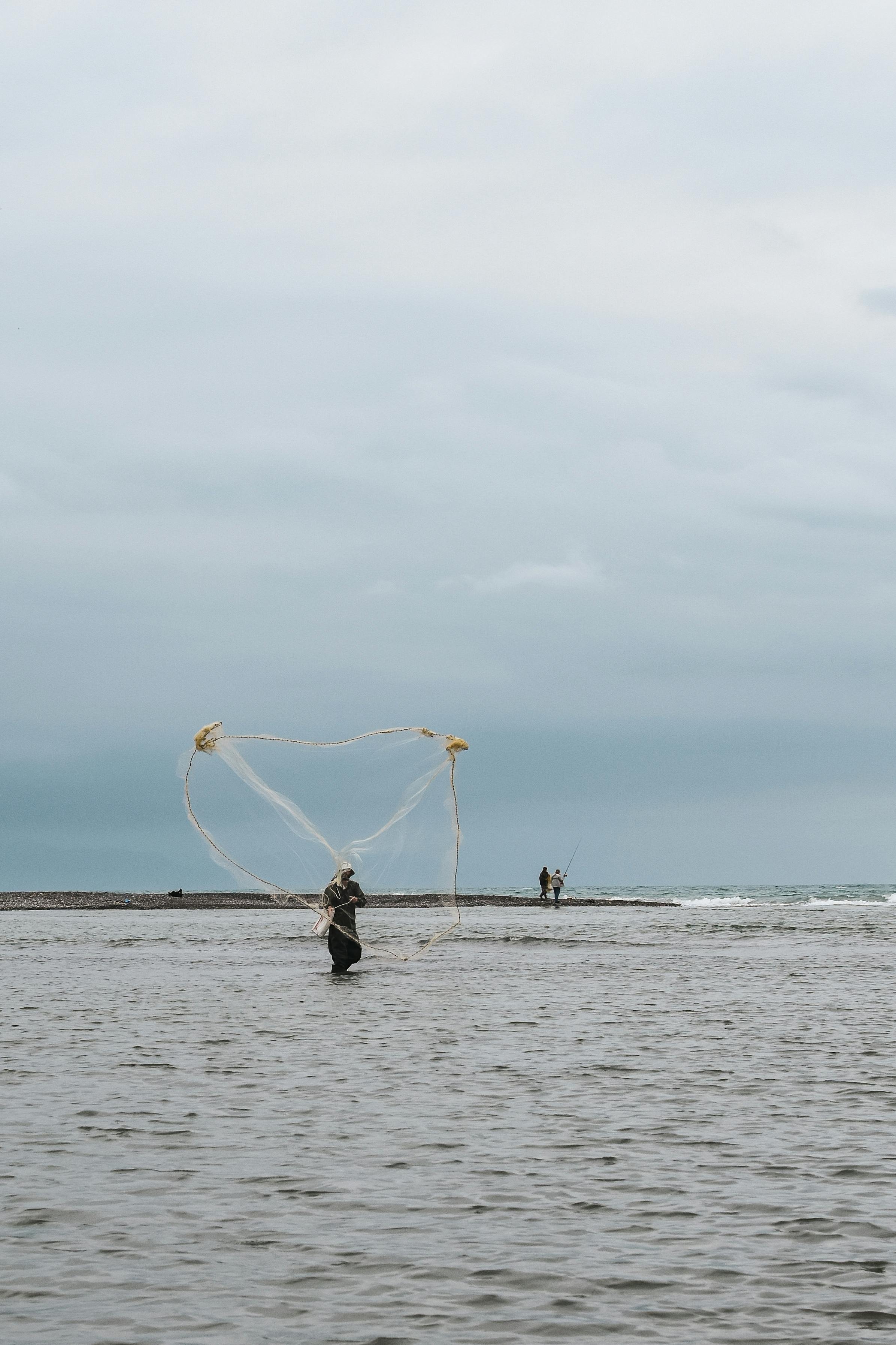 Man Throwing Fishing Net · Free Stock Photo