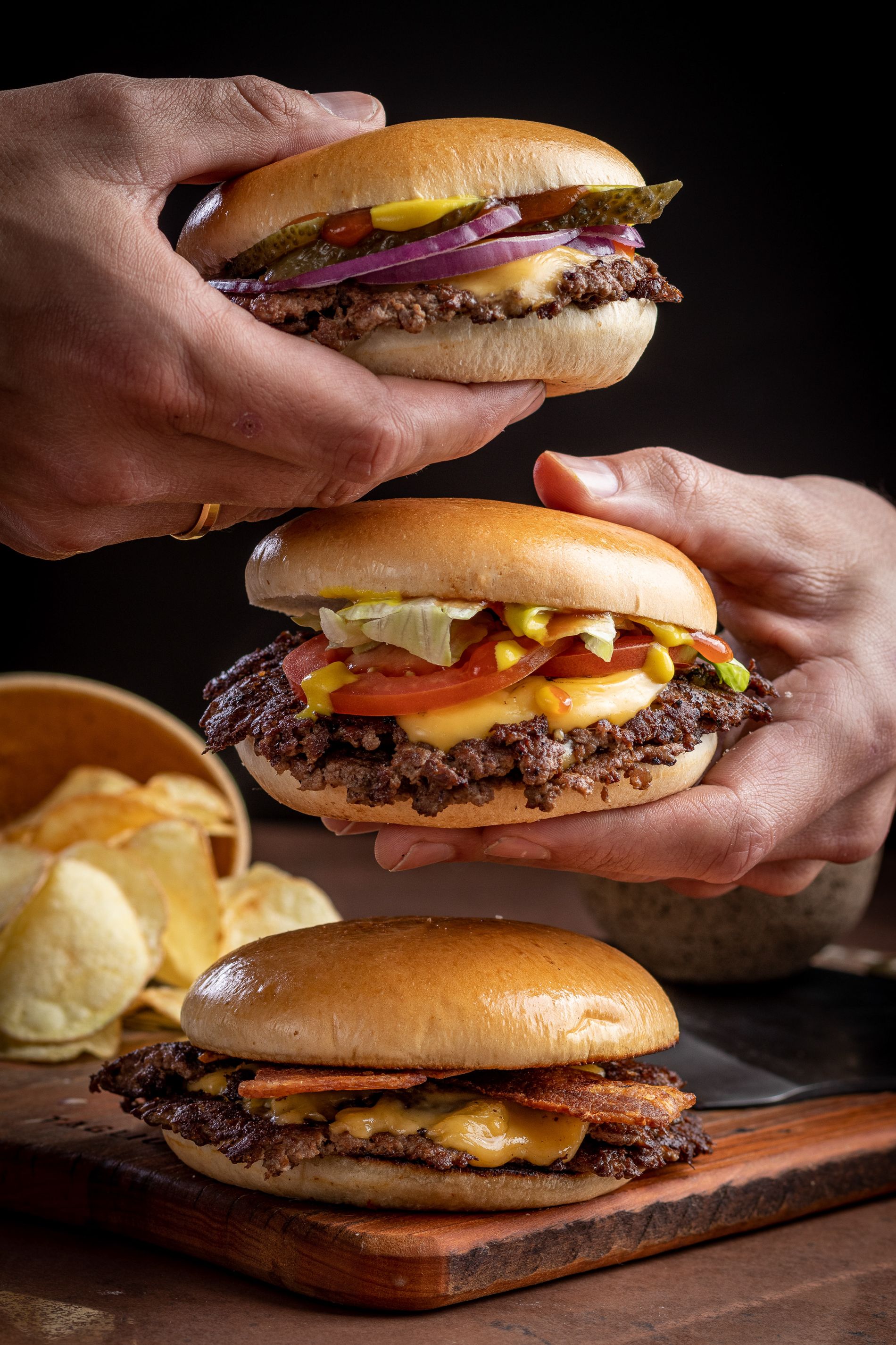Hand Holding Cheeseburger · Free Stock Photo