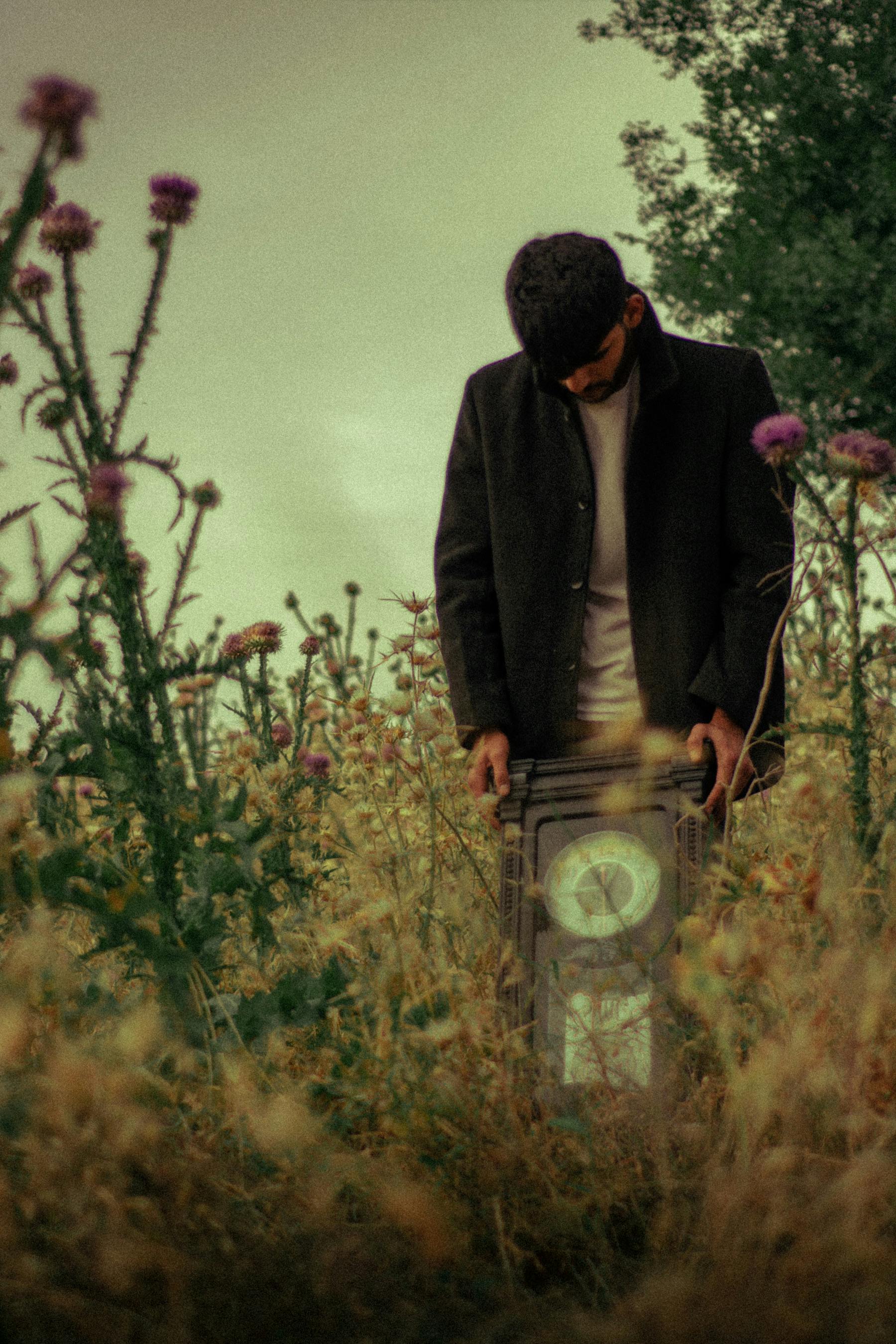 Man Holding Vintage Clock on Meadow · Free Stock Photo