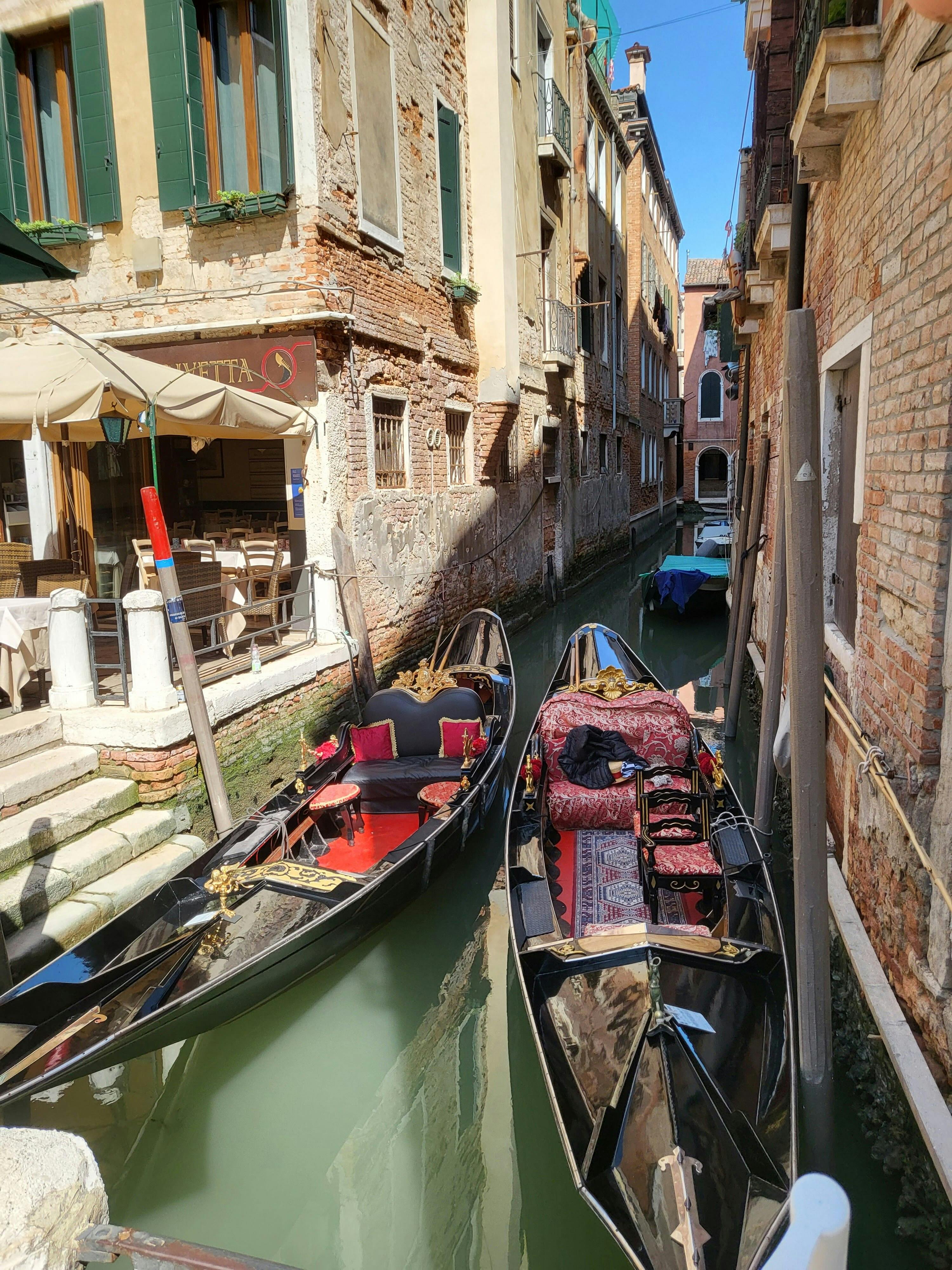 Gondolas On The Sides Of A Tight Passage On The Grand Canal In Venice