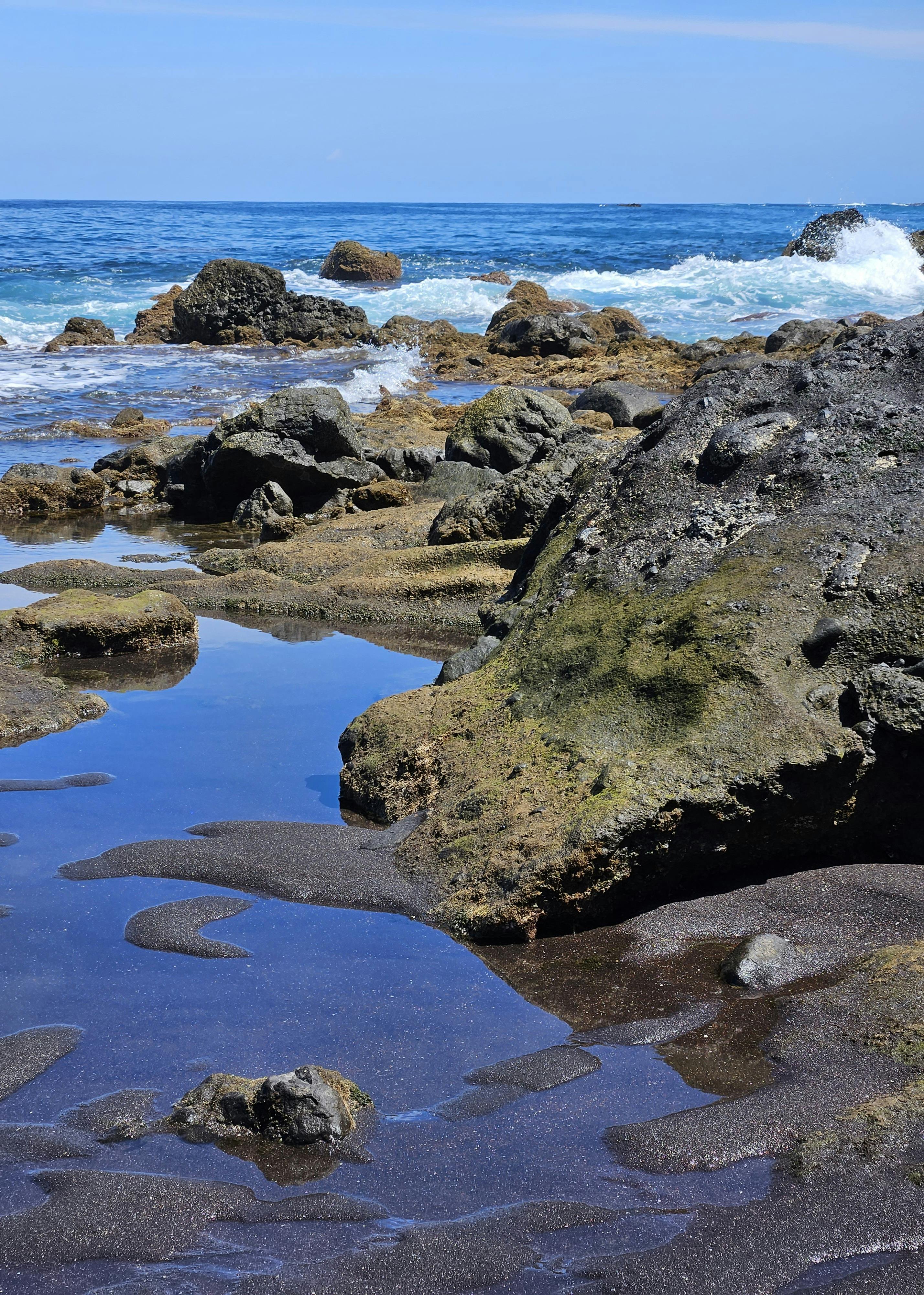Photo of Rock Formation Near Seashore Under Blue Sky · Free Stock Photo