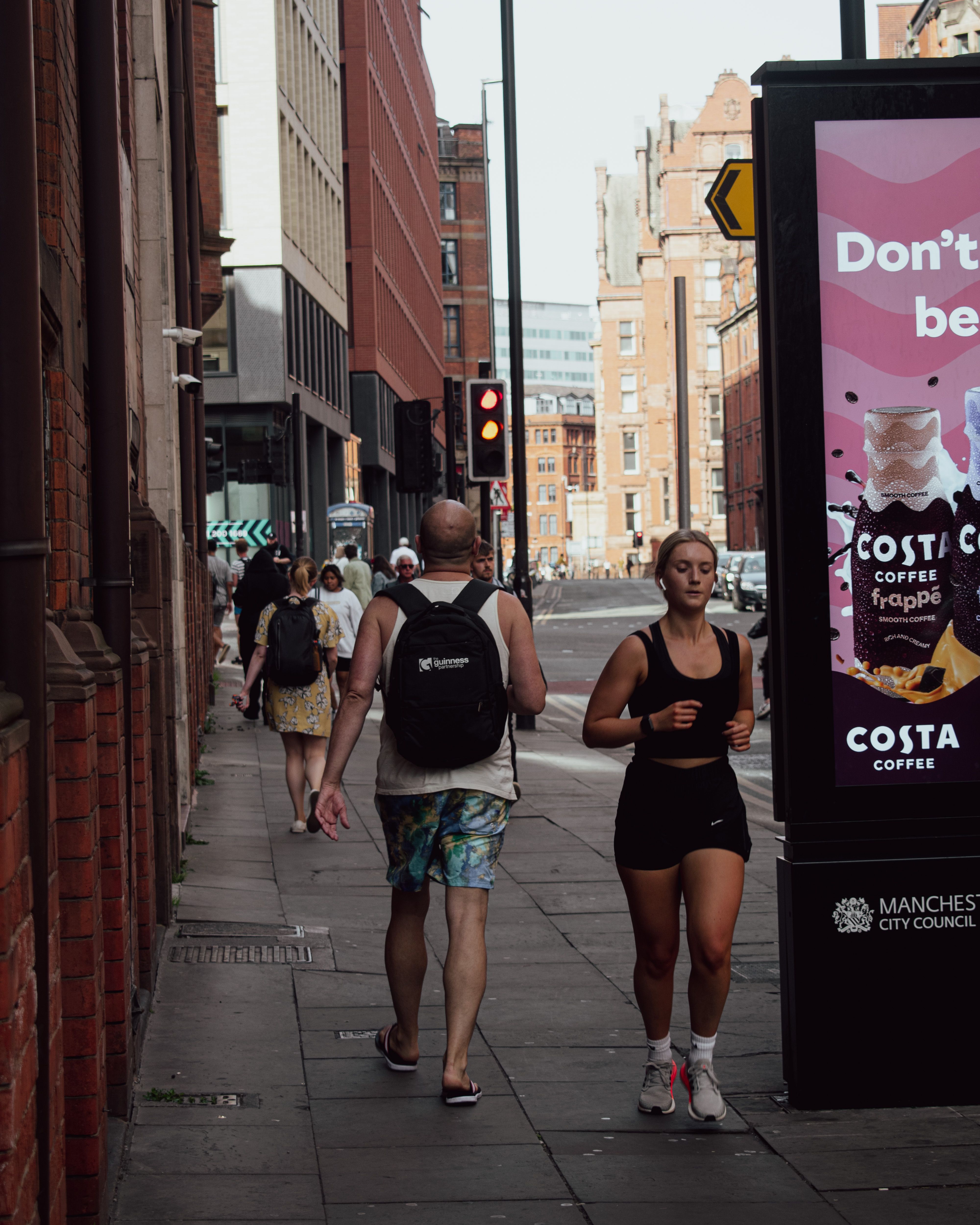 Woman Jogging on Sidewalk in City · Free Stock Photo