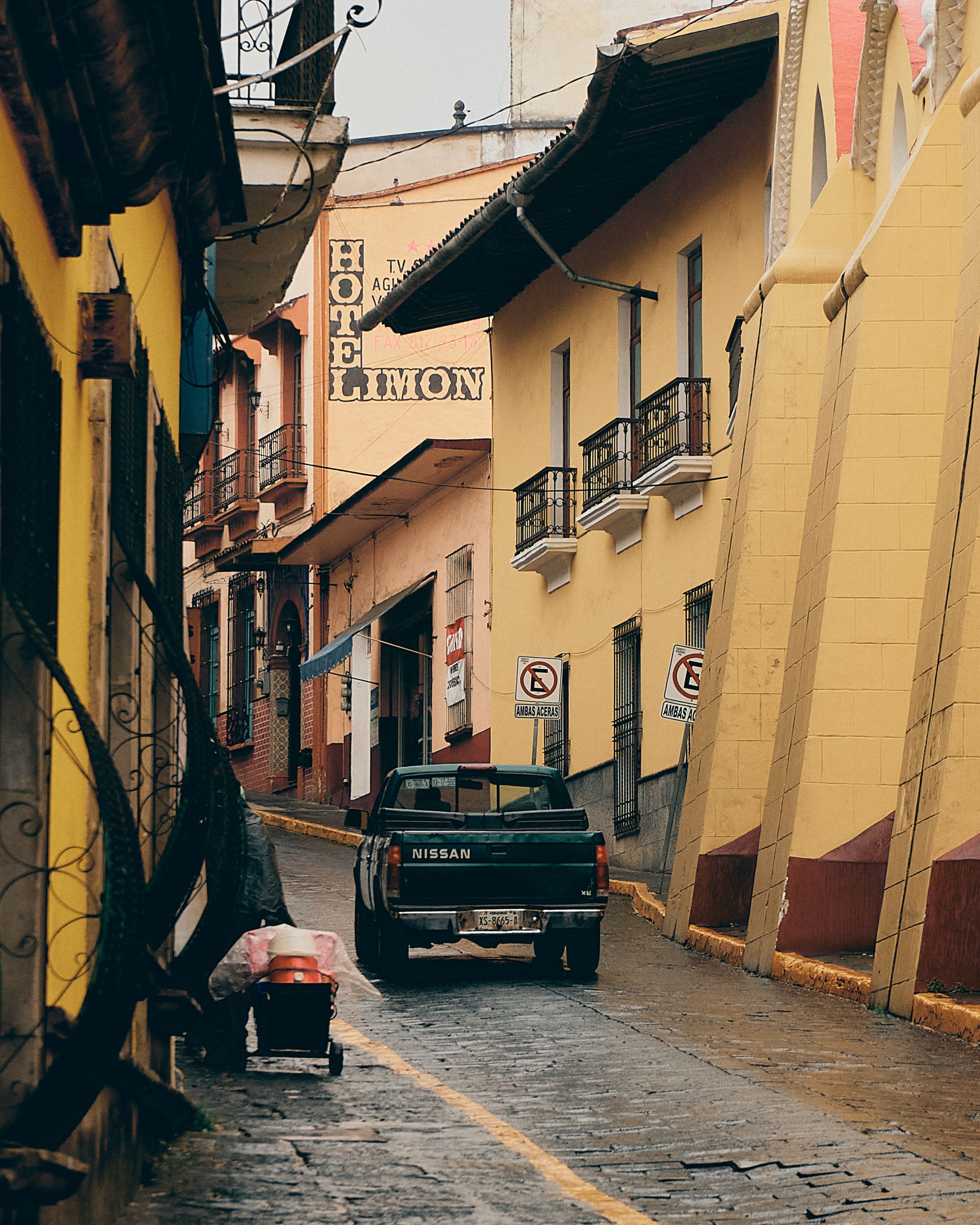 Pick-up Truck in a Narrow Town Street · Free Stock Photo