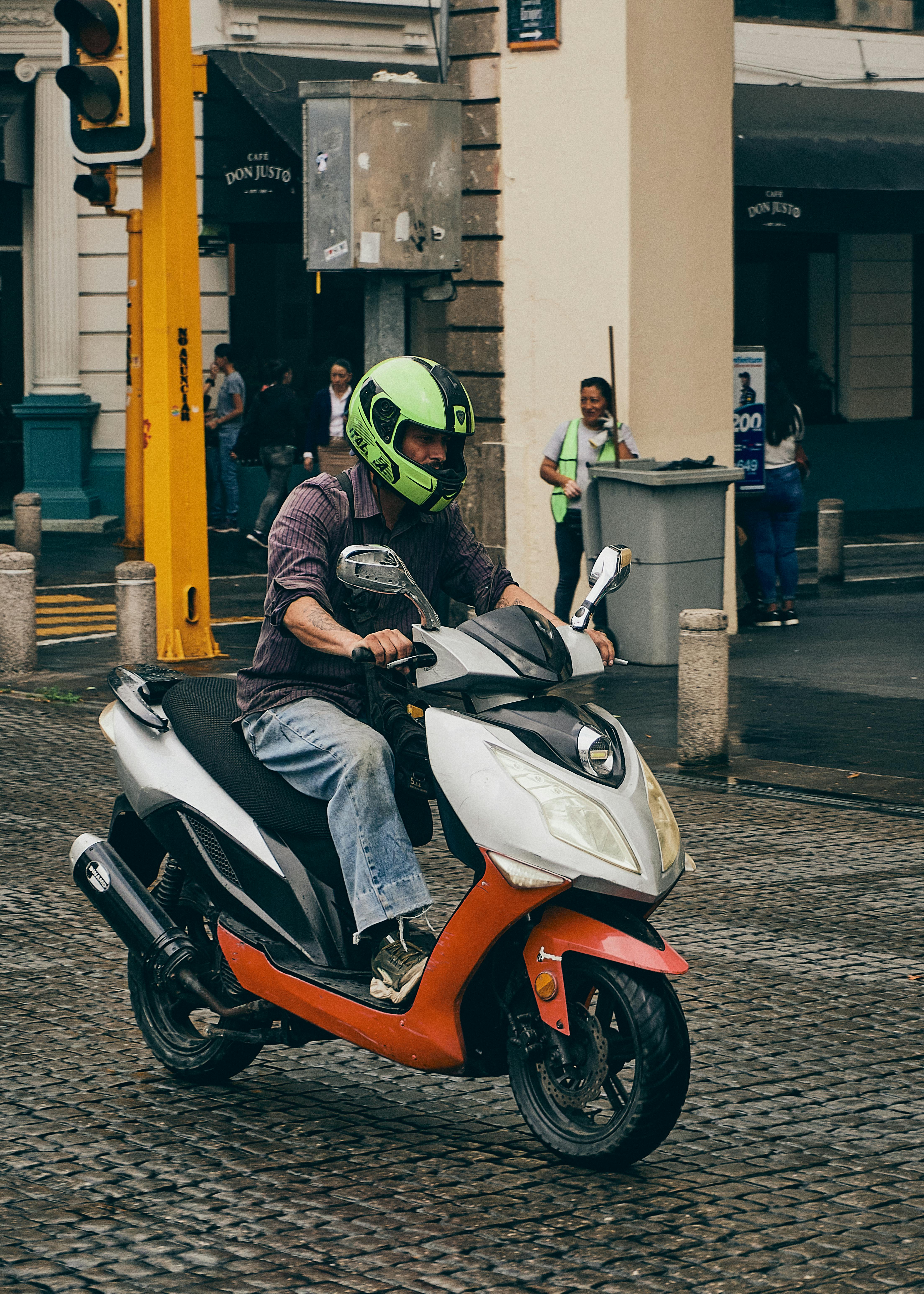 Driver Riding a Scooter · Free Stock Photo
