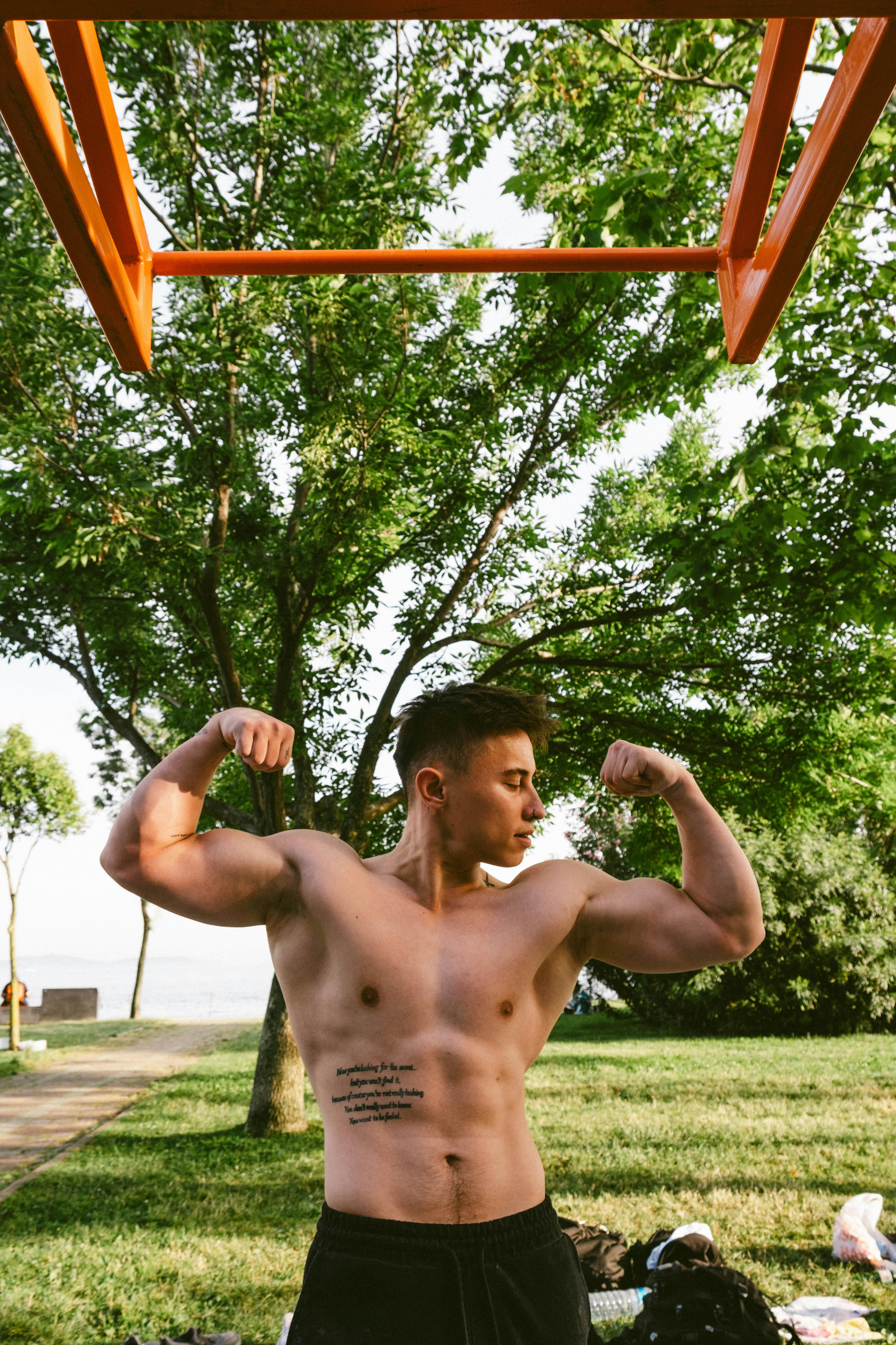 Young Muscular Man Standing Outside Shirtless and Flexing His Muscles ...