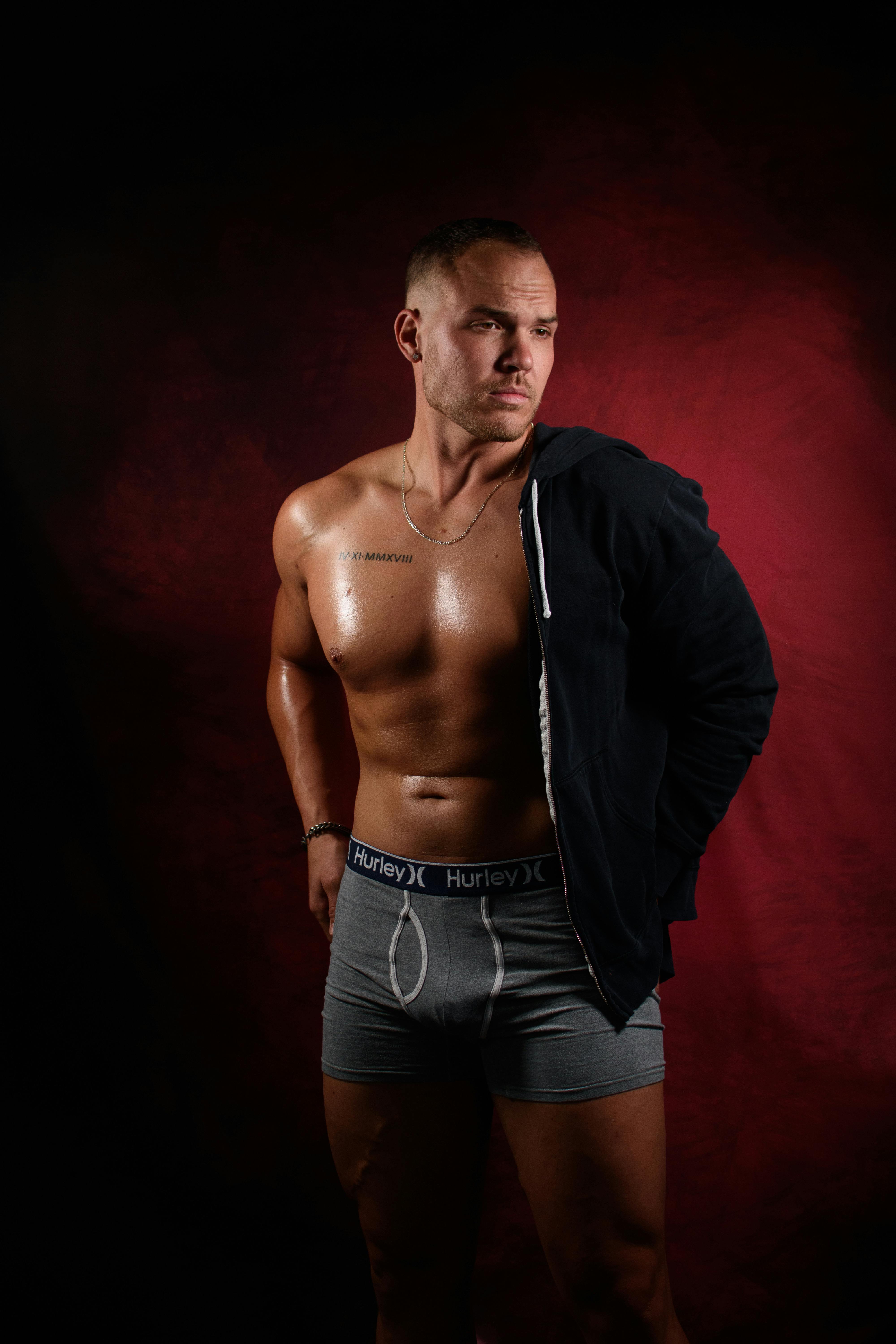 Model in Gray Boxer Shorts and a Partially Worn Hoodie · Free Stock Photo