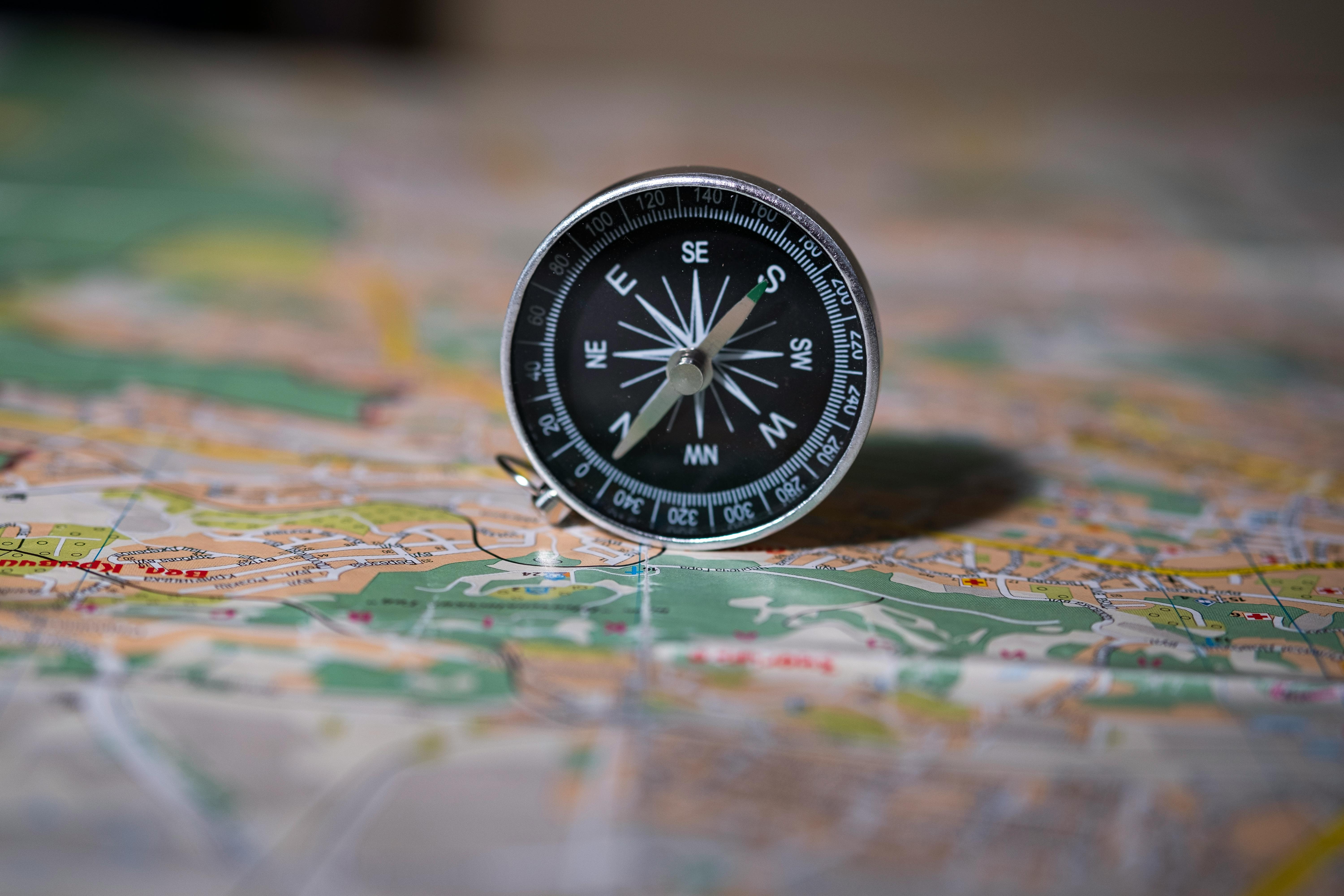 compass on the background of the map. travel concept. route planning ...