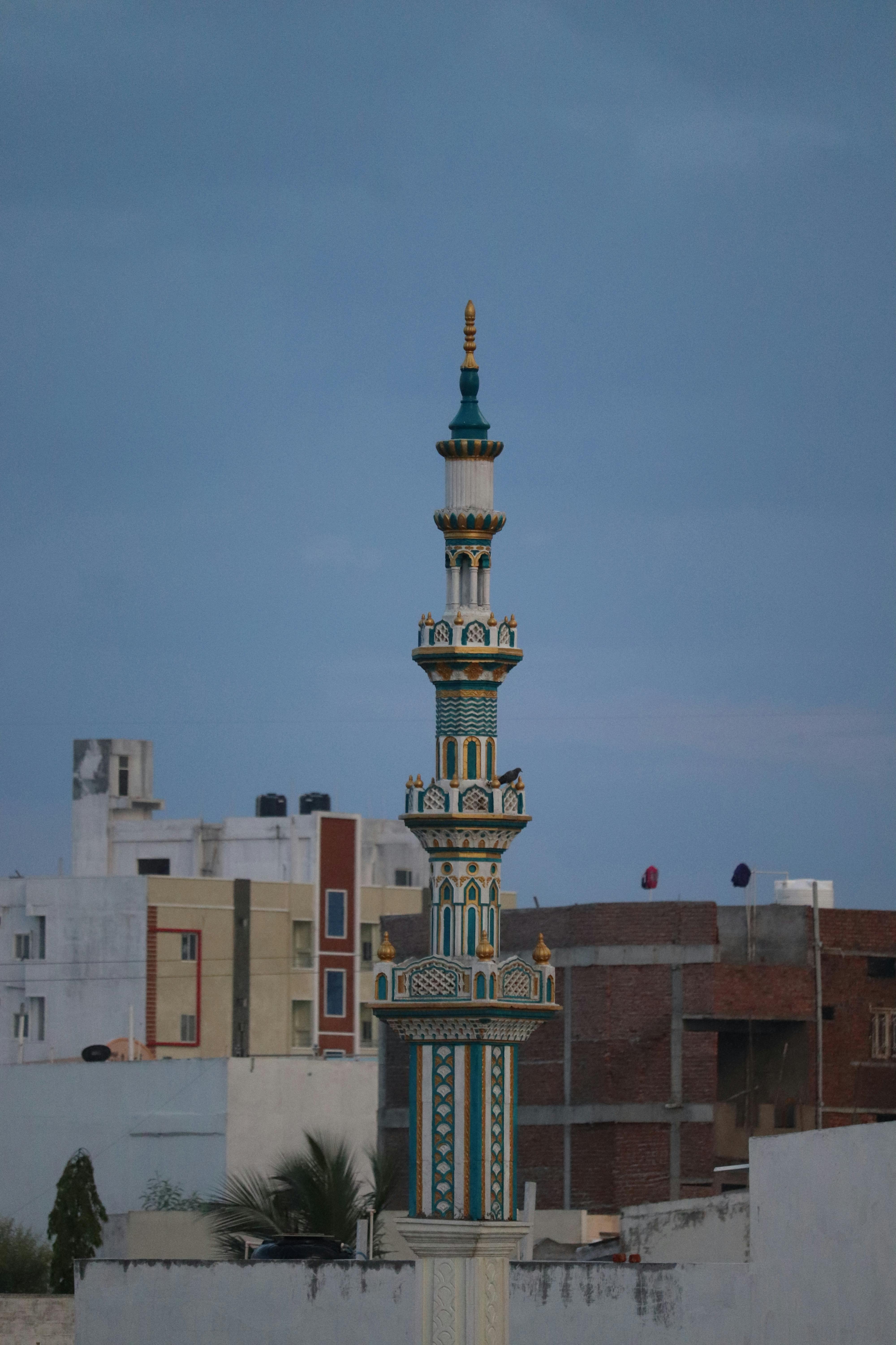 View of a Minaret on the Background of Apartment Buildings in City ...