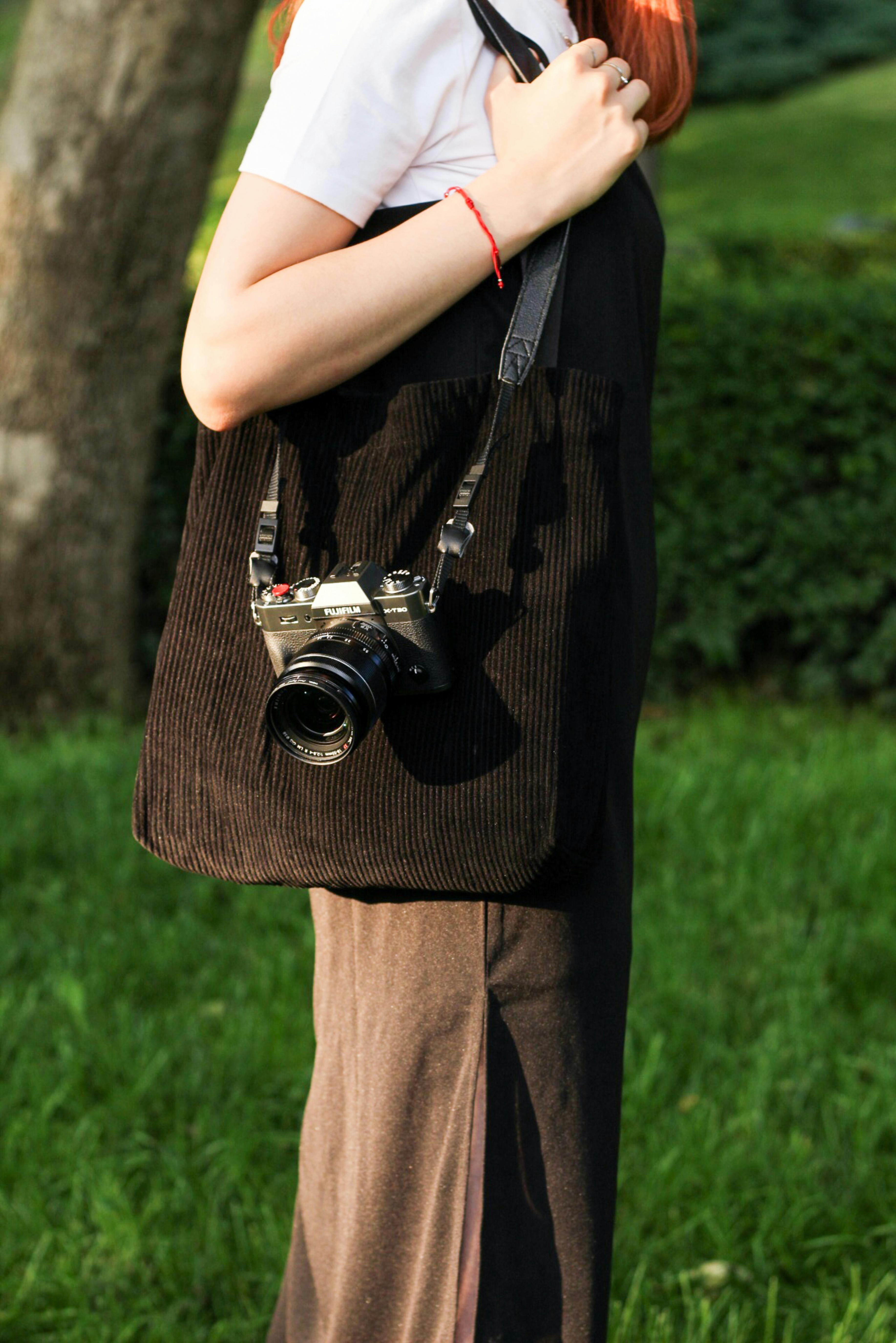 Woman Wearing Tote Bag and Camera on her Shoulder · Free Stock Photo