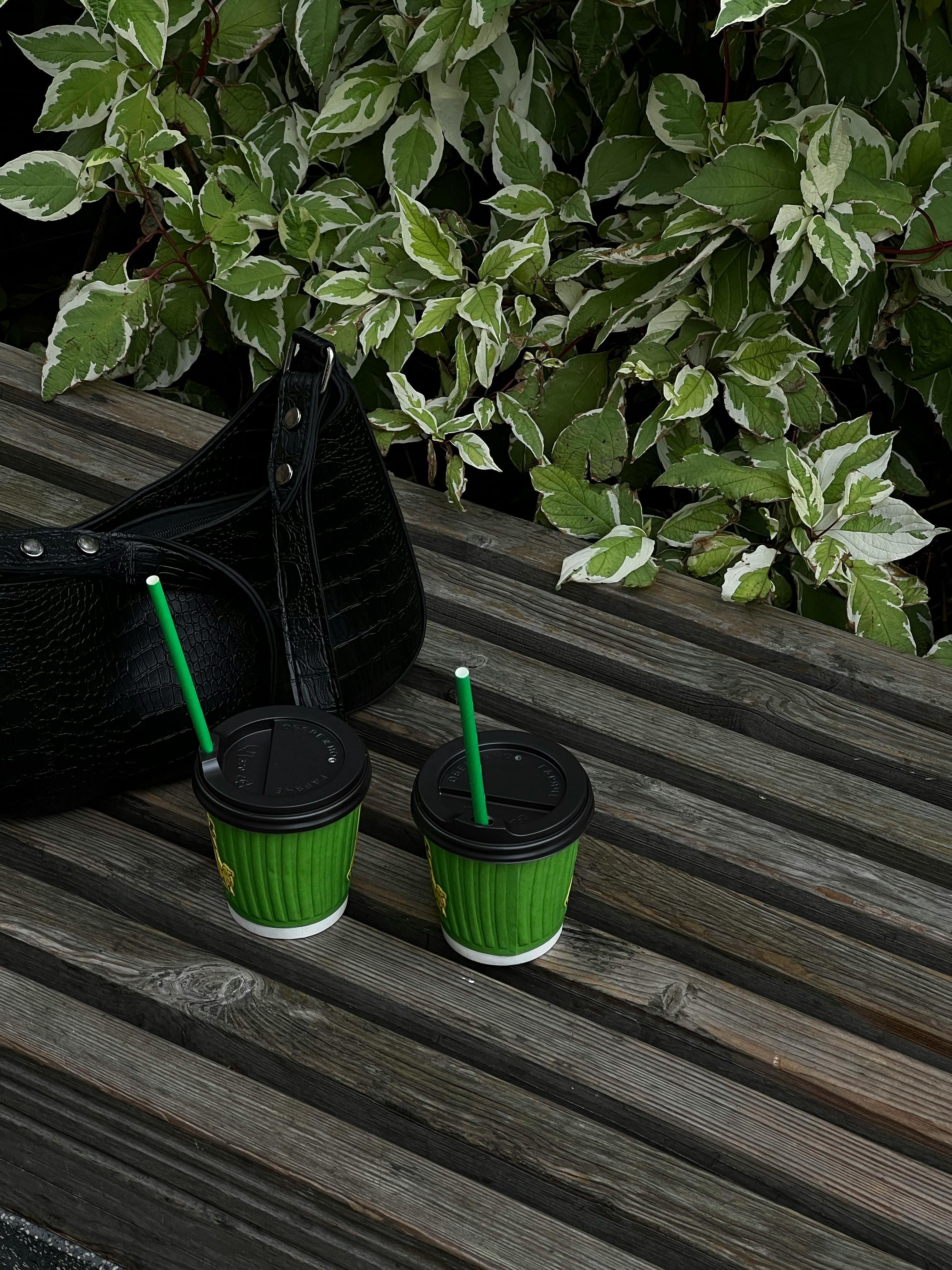 Cups with Straws near Bag on Bench · Free Stock Photo