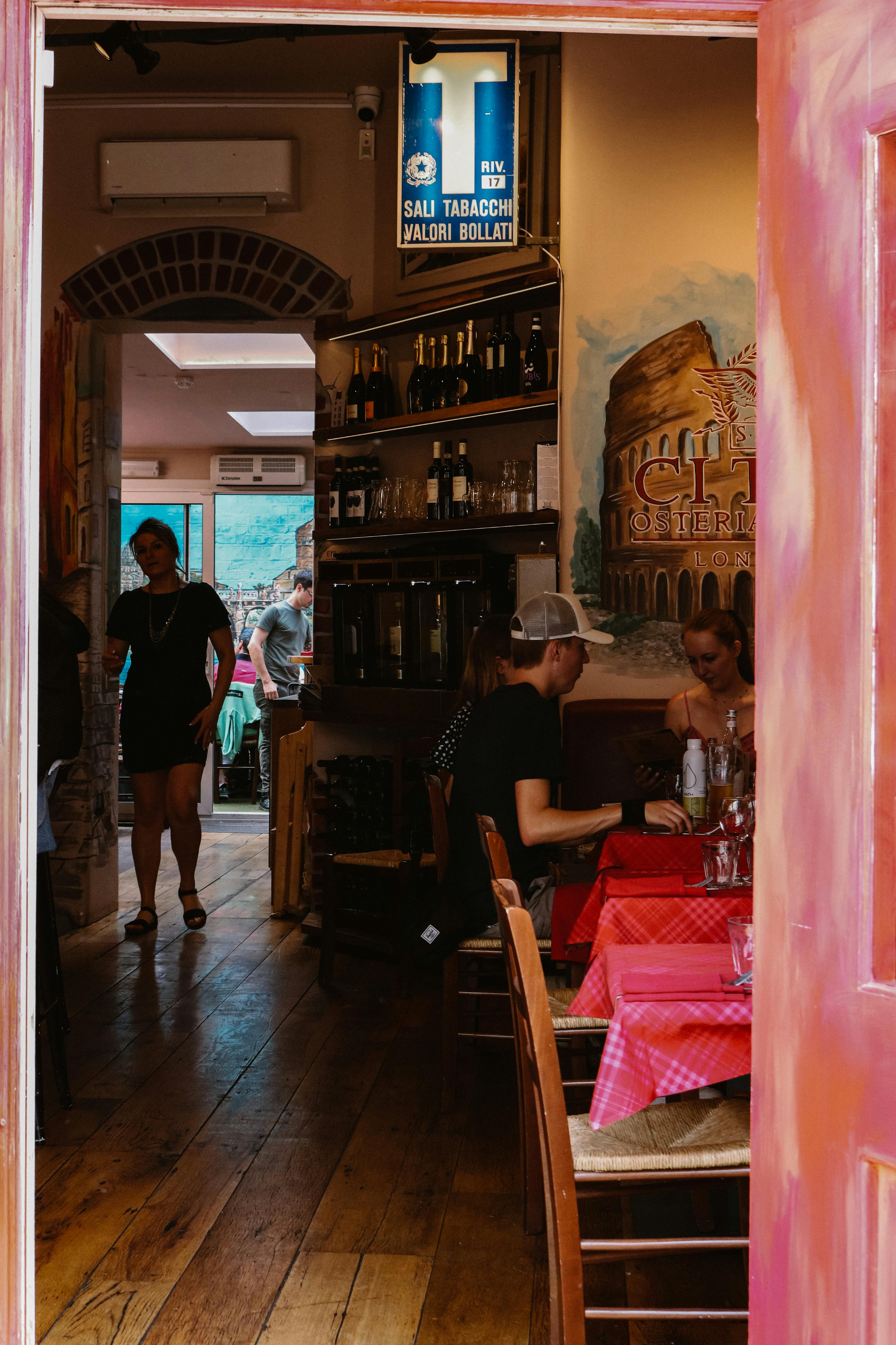 A Woman Walking into a Bar · Free Stock Photo
