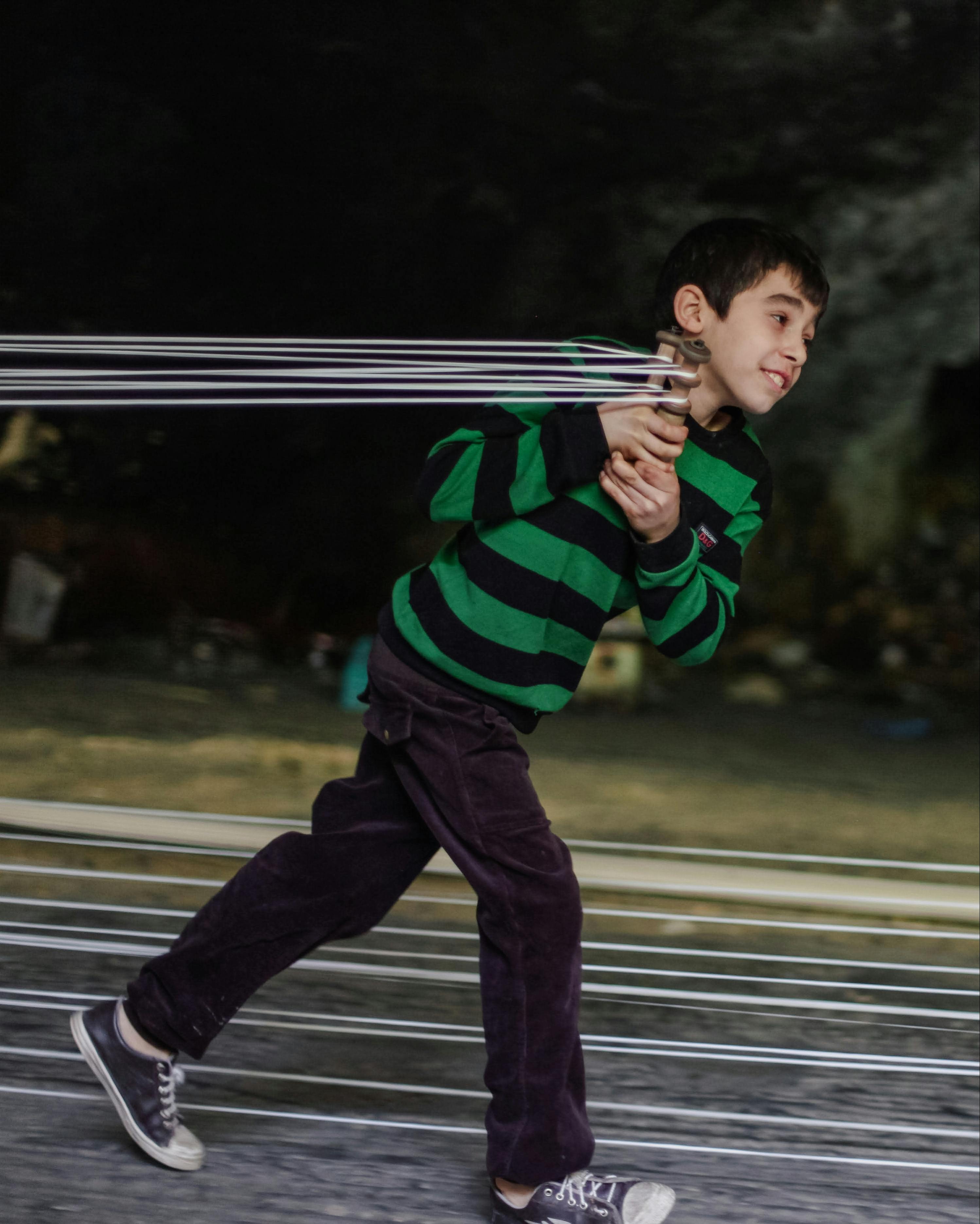 Boy Walking and Towing Strings · Free Stock Photo