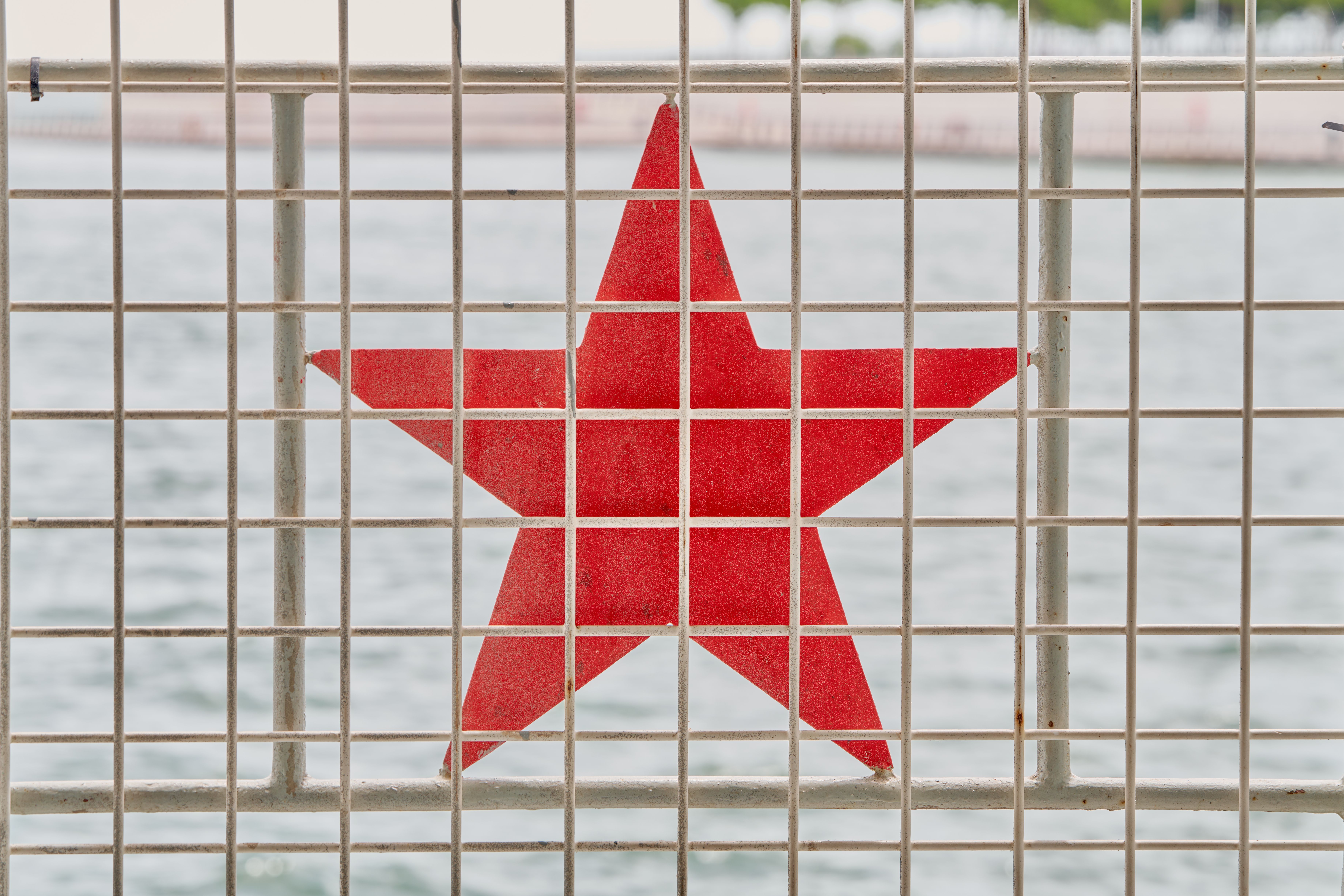 Red Star Hanging on Fence · Free Stock Photo