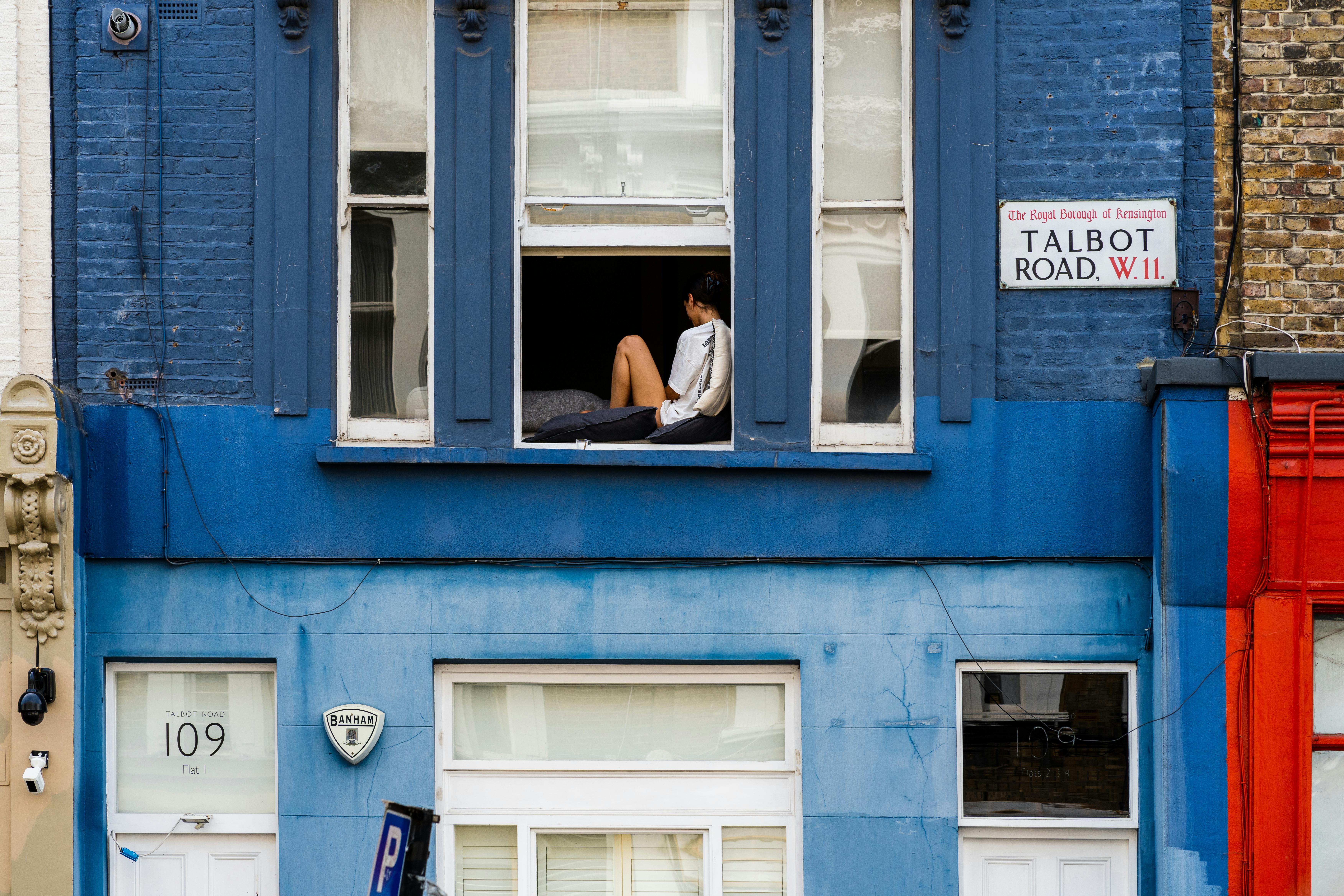 Woman Sitting in Window · Free Stock Photo