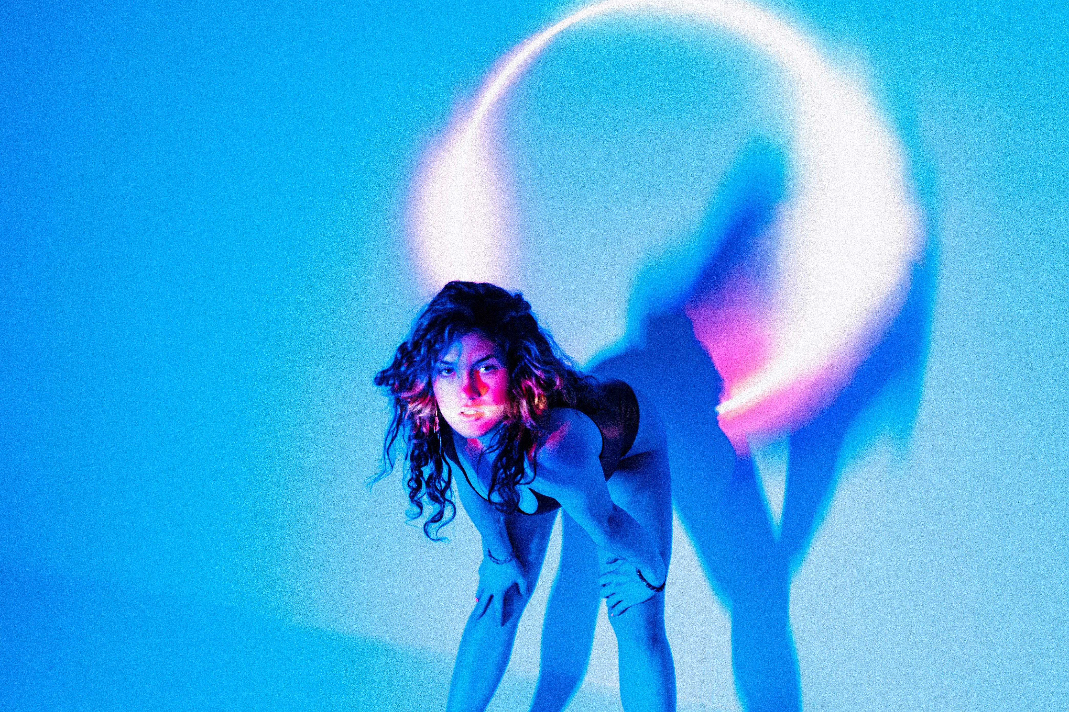 Light behind Woman Bending · Free Stock Photo