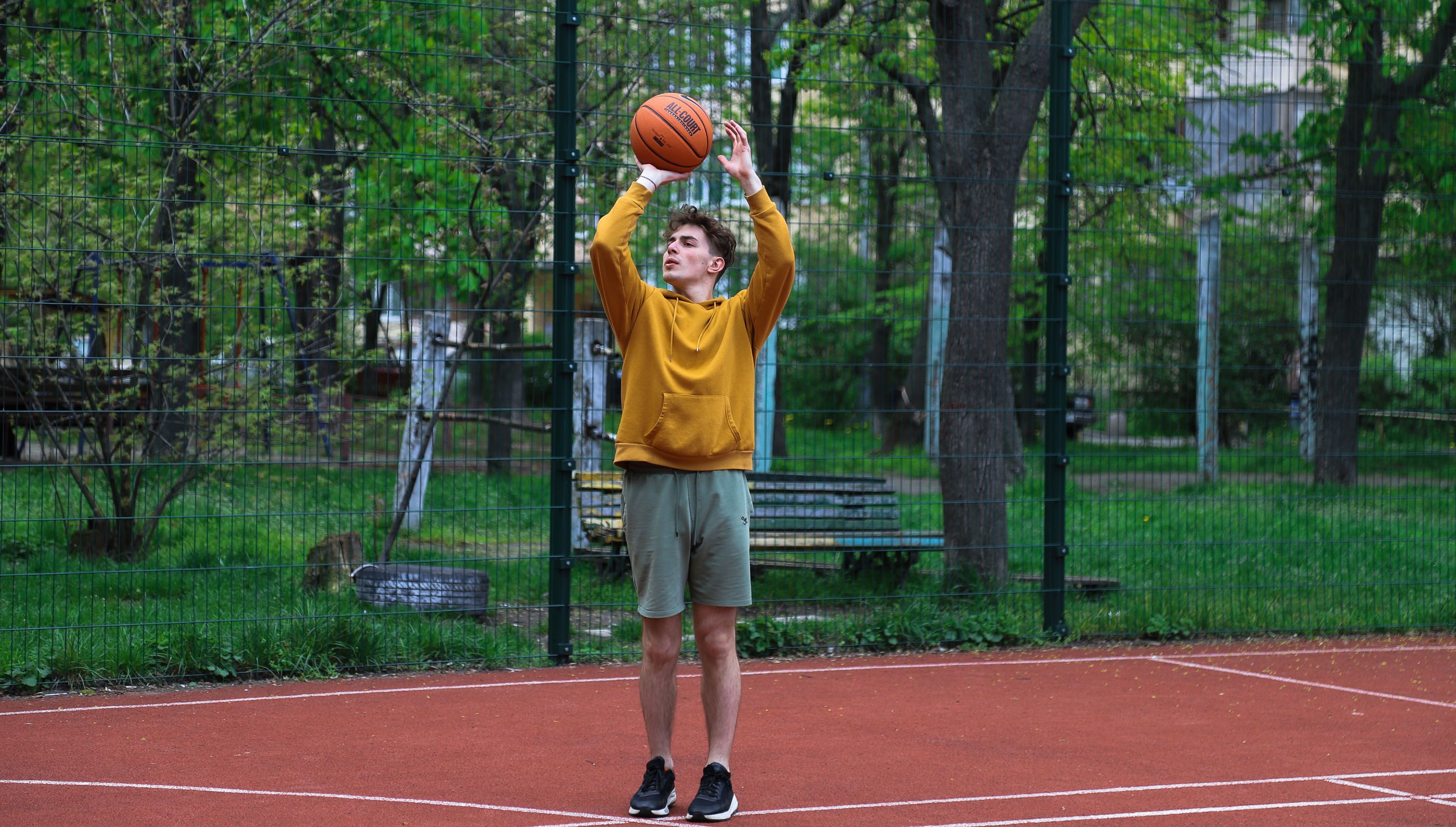 Teenager in Yellow Jumper Throwing Ball on Basketball Court · Free ...