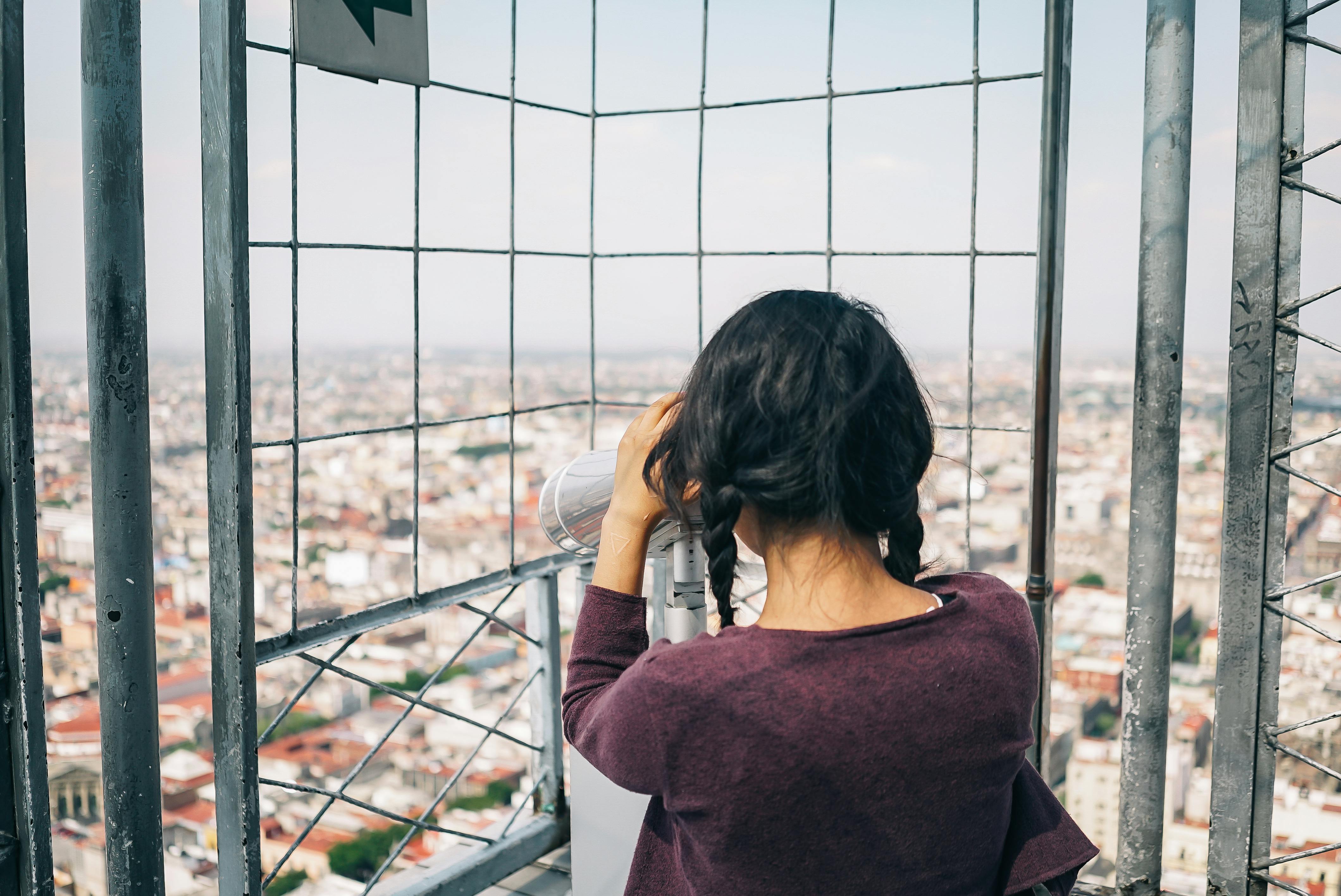 A Person Standing on High Ground Overlooking the City · Free Stock Photo