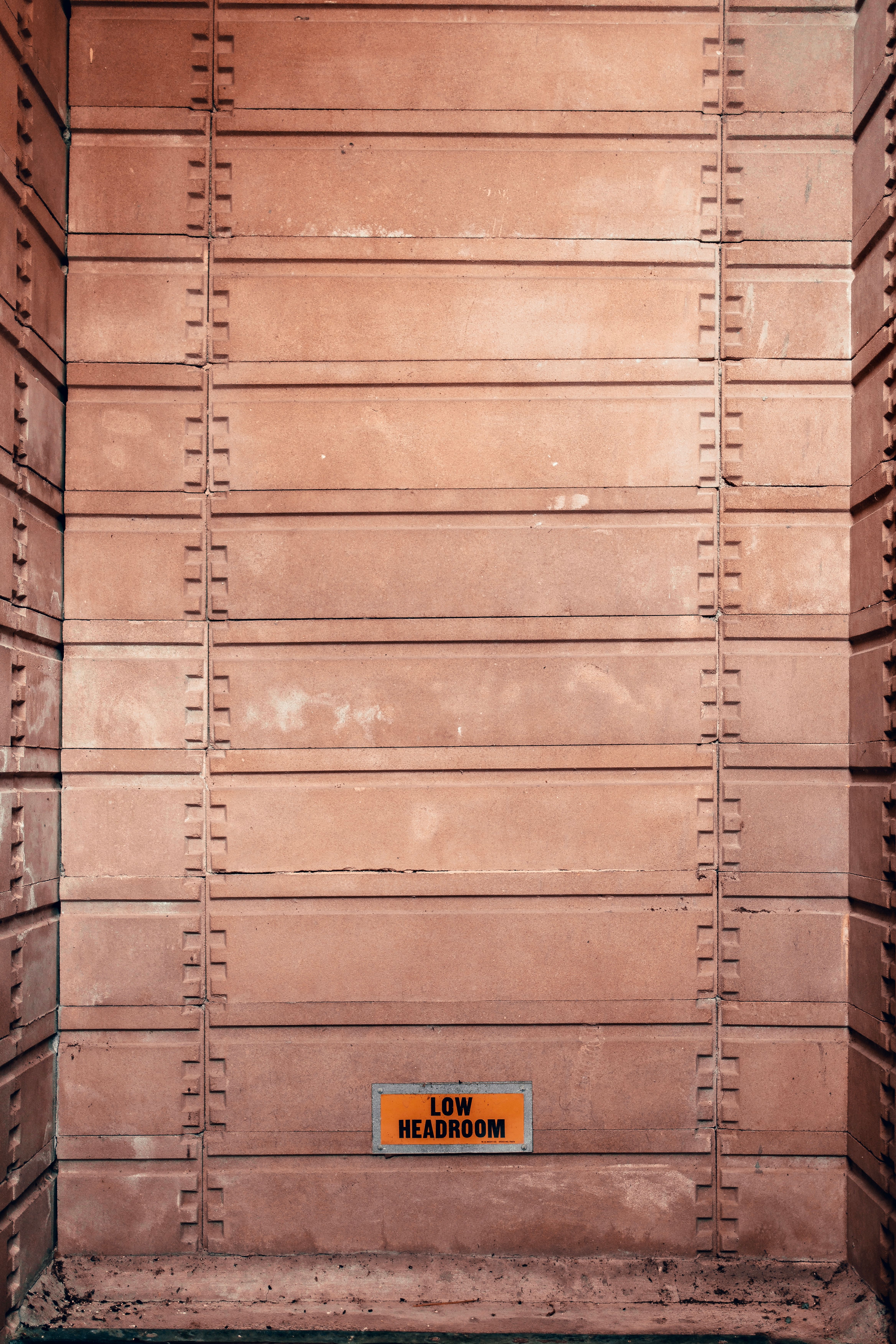 Warning Sign under Brown Wall · Free Stock Photo