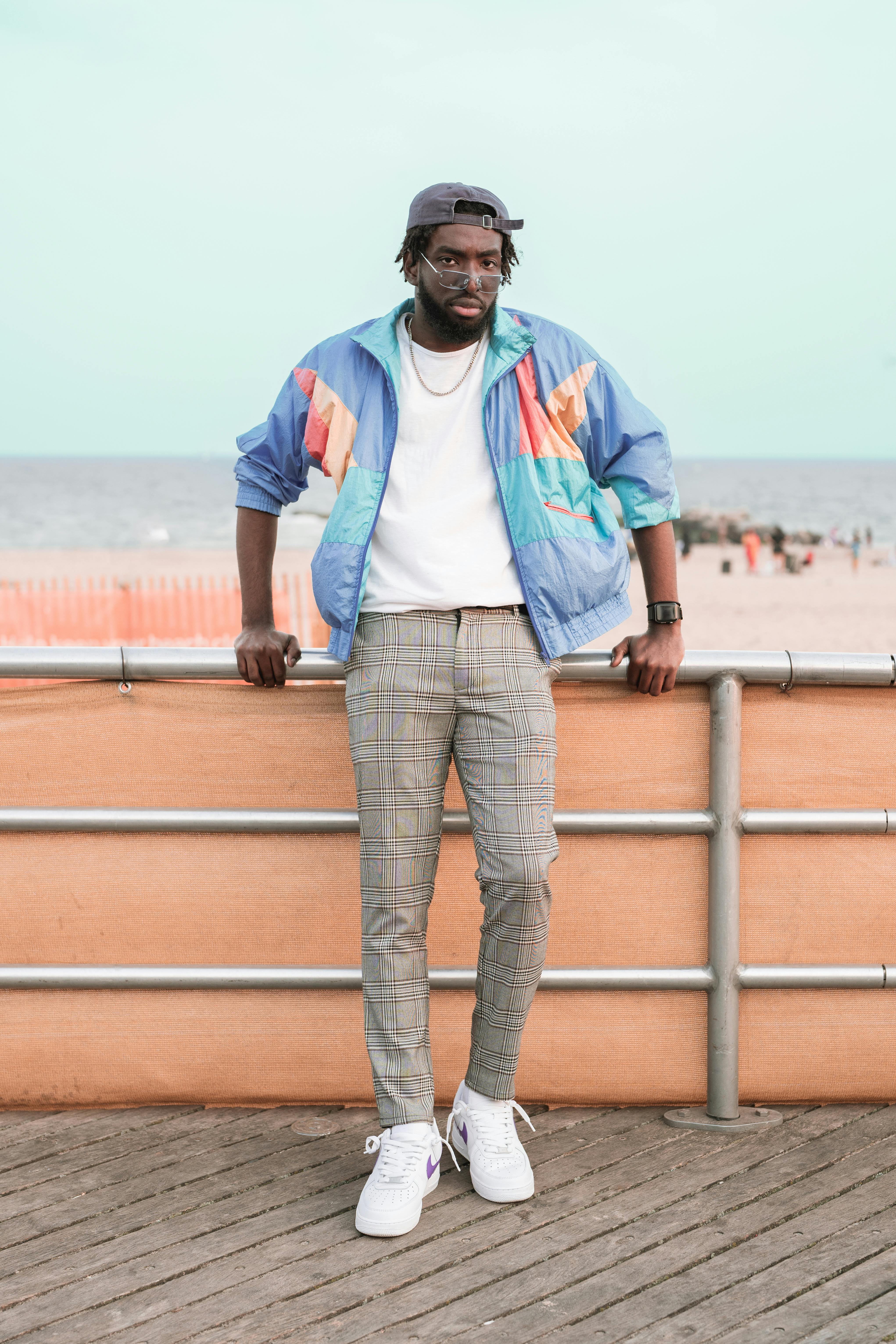 Man Posing in Jacket and Cap · Free Stock Photo