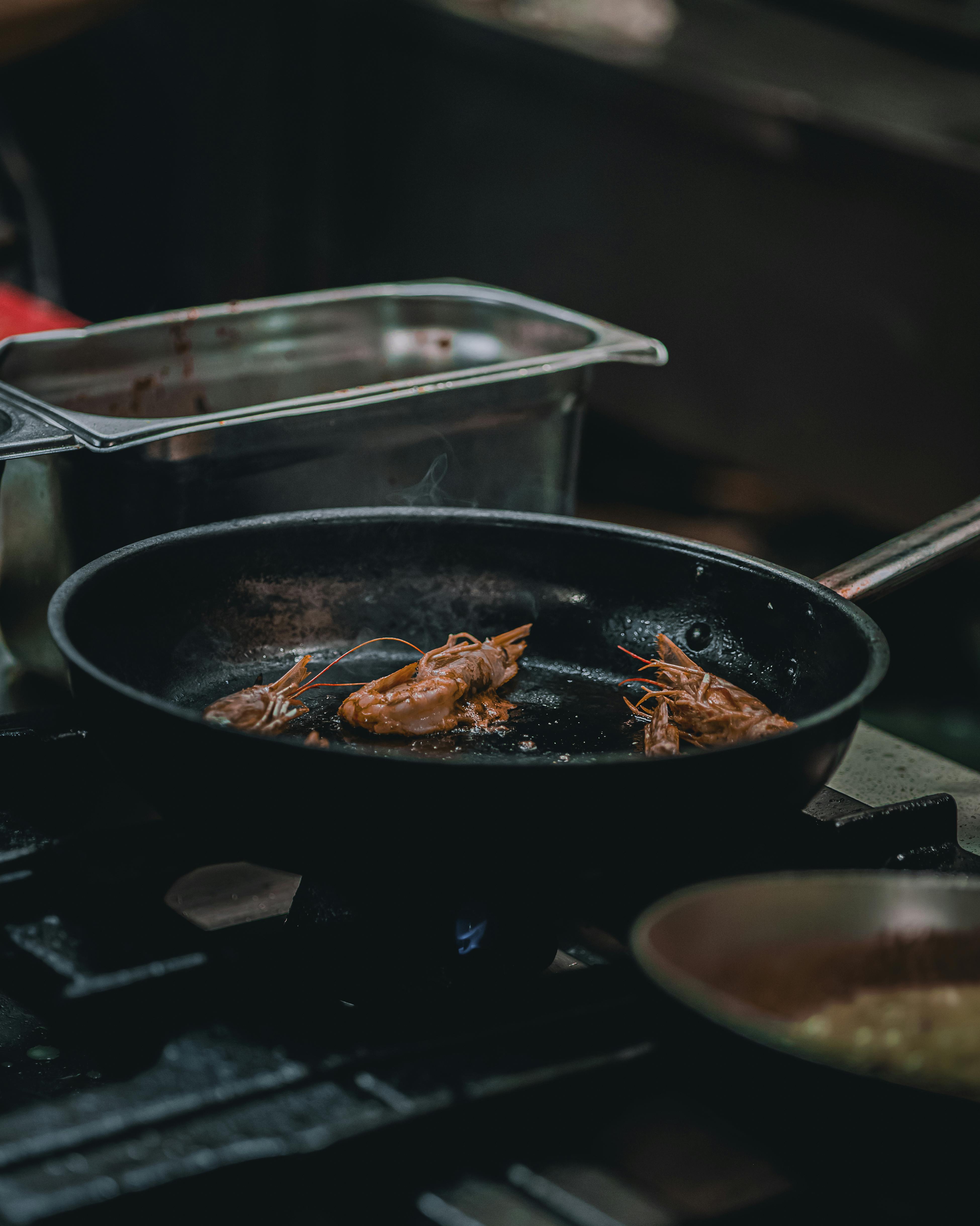 Woman Eating on Cooking Pan · Free Stock Photo