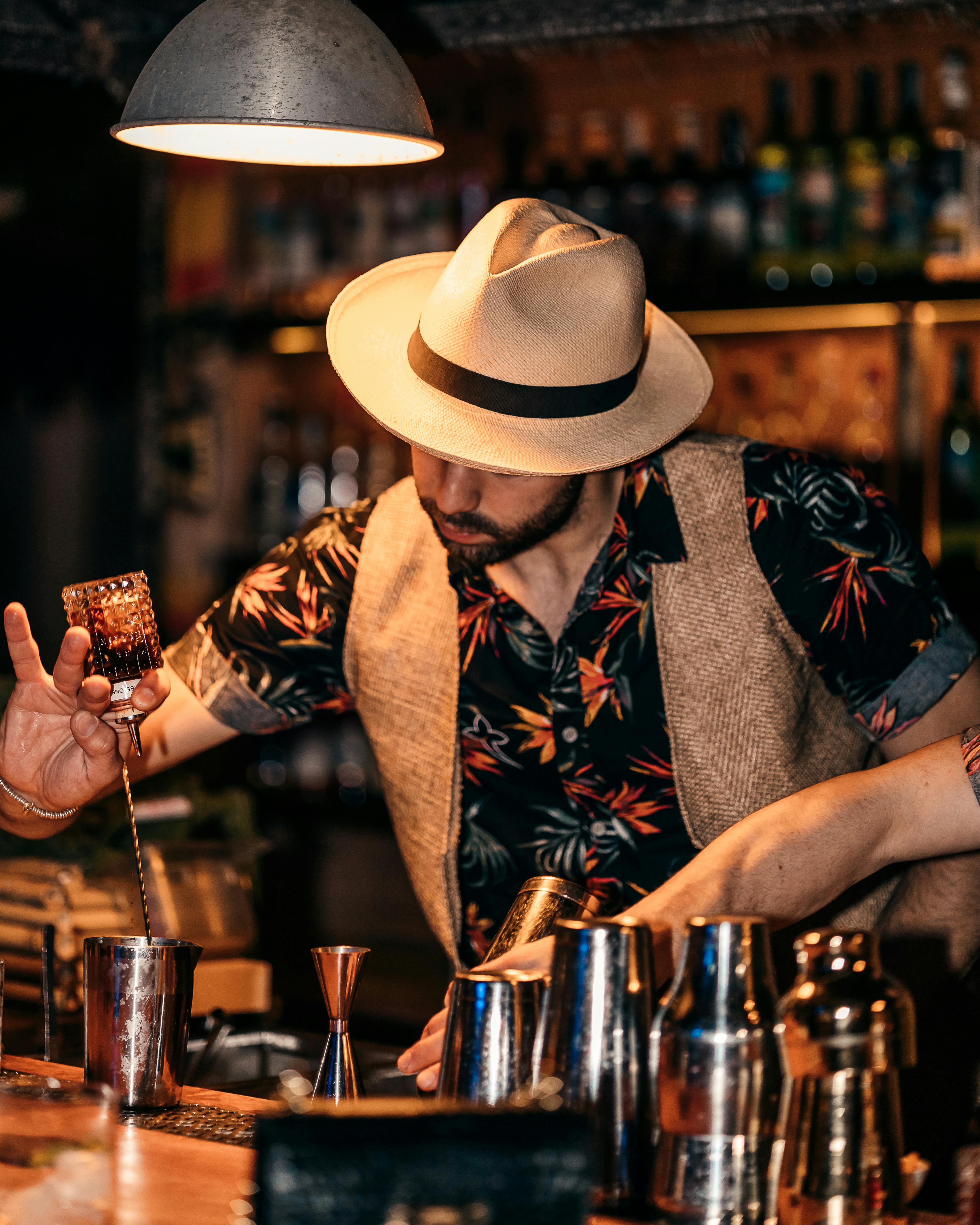 Bartender in Panama Hat, Vest and Tropical Pattern Shirt Preparing a ...