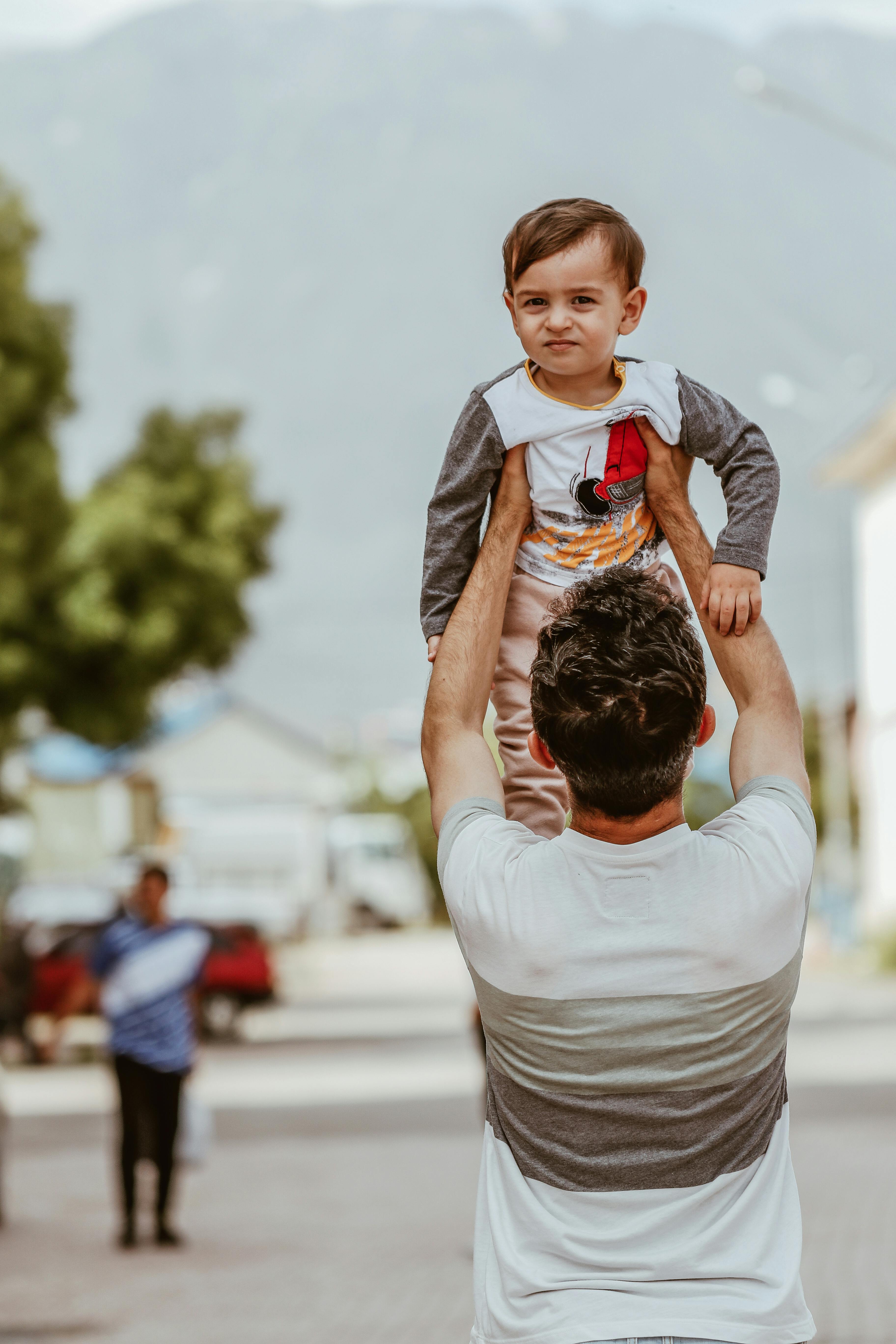 Father Lifting Up His Little Son · Free Stock Photo