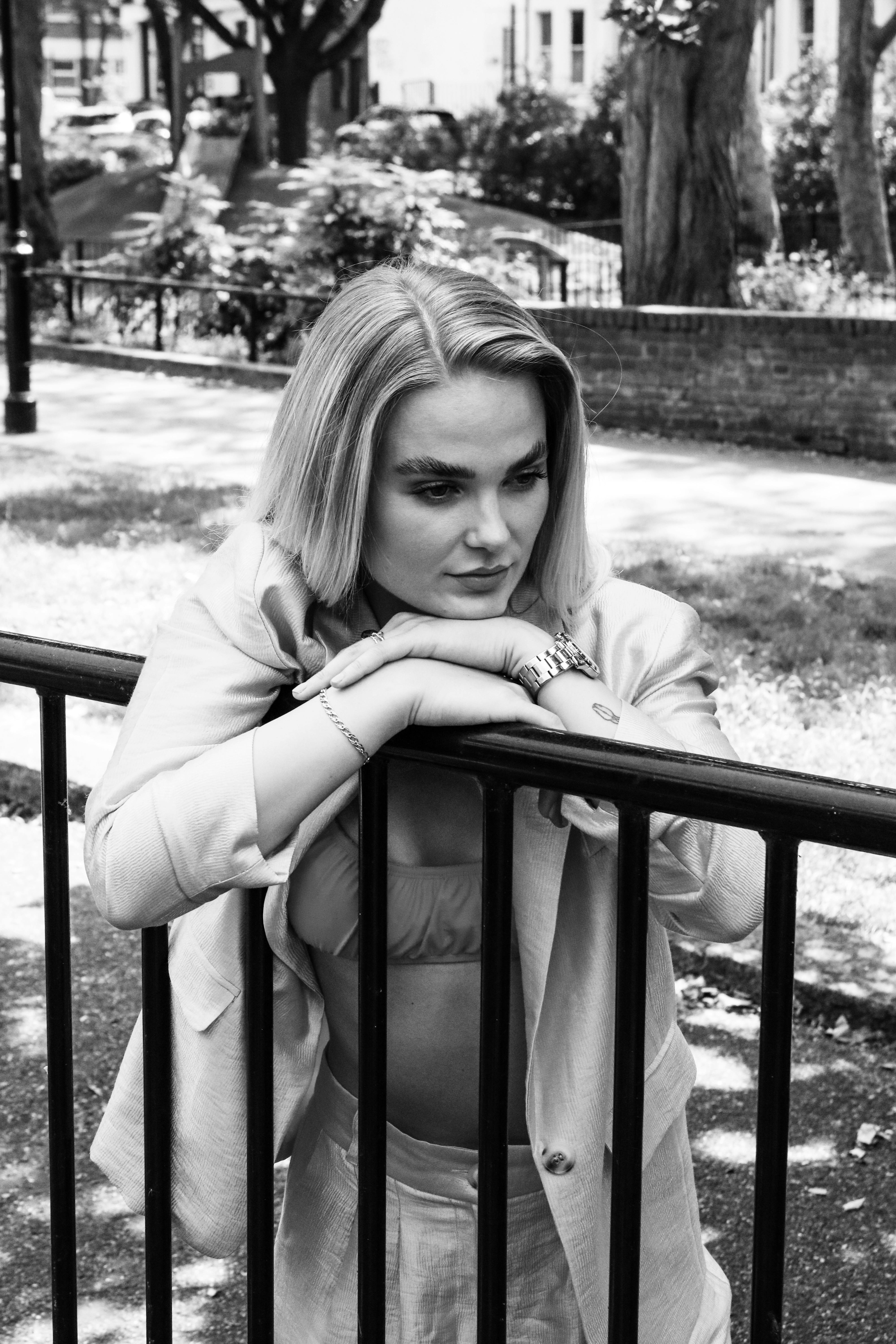 Woman Leaning on Railing and Posing · Free Stock Photo