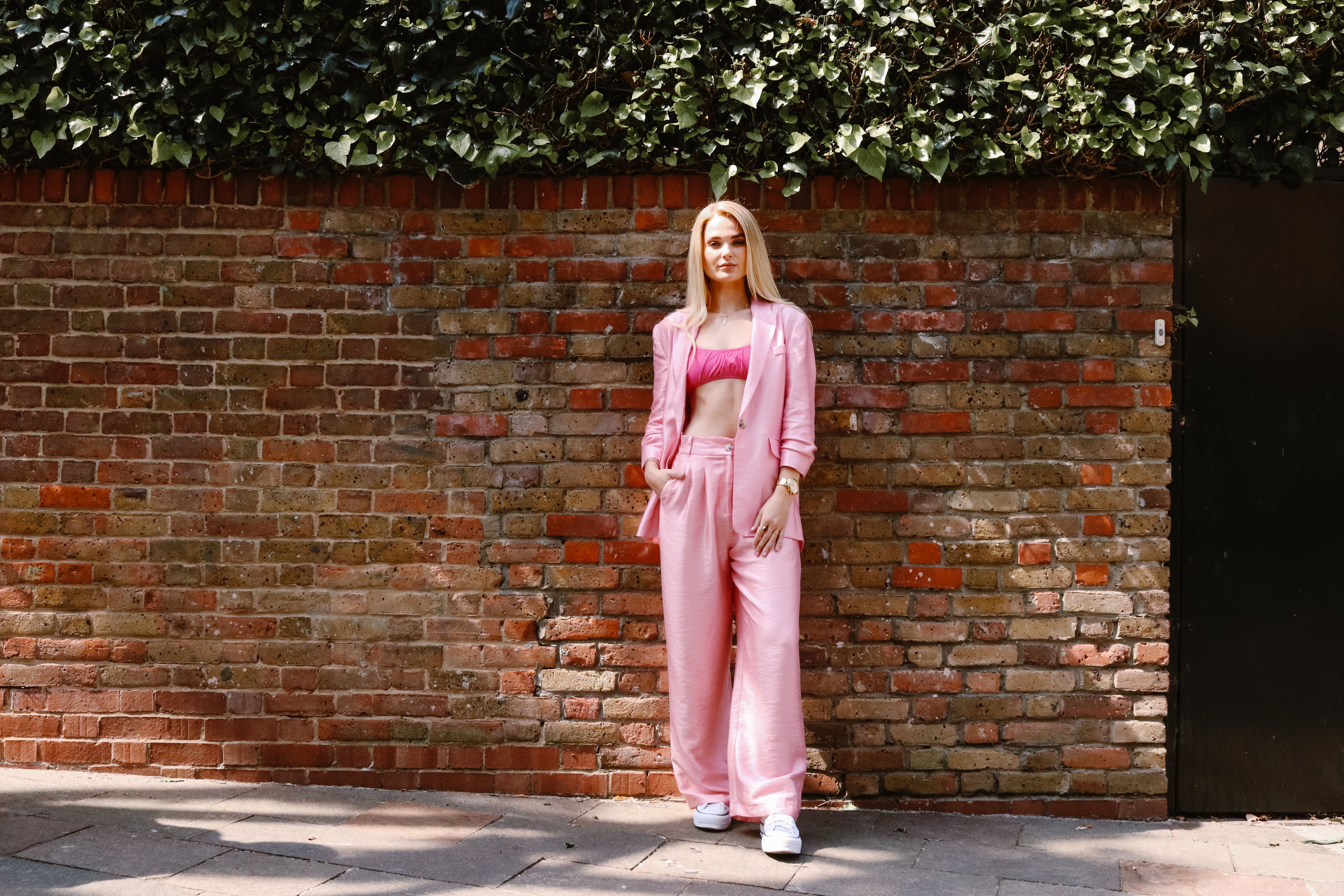 Blonde Woman Posing by Wall · Free Stock Photo
