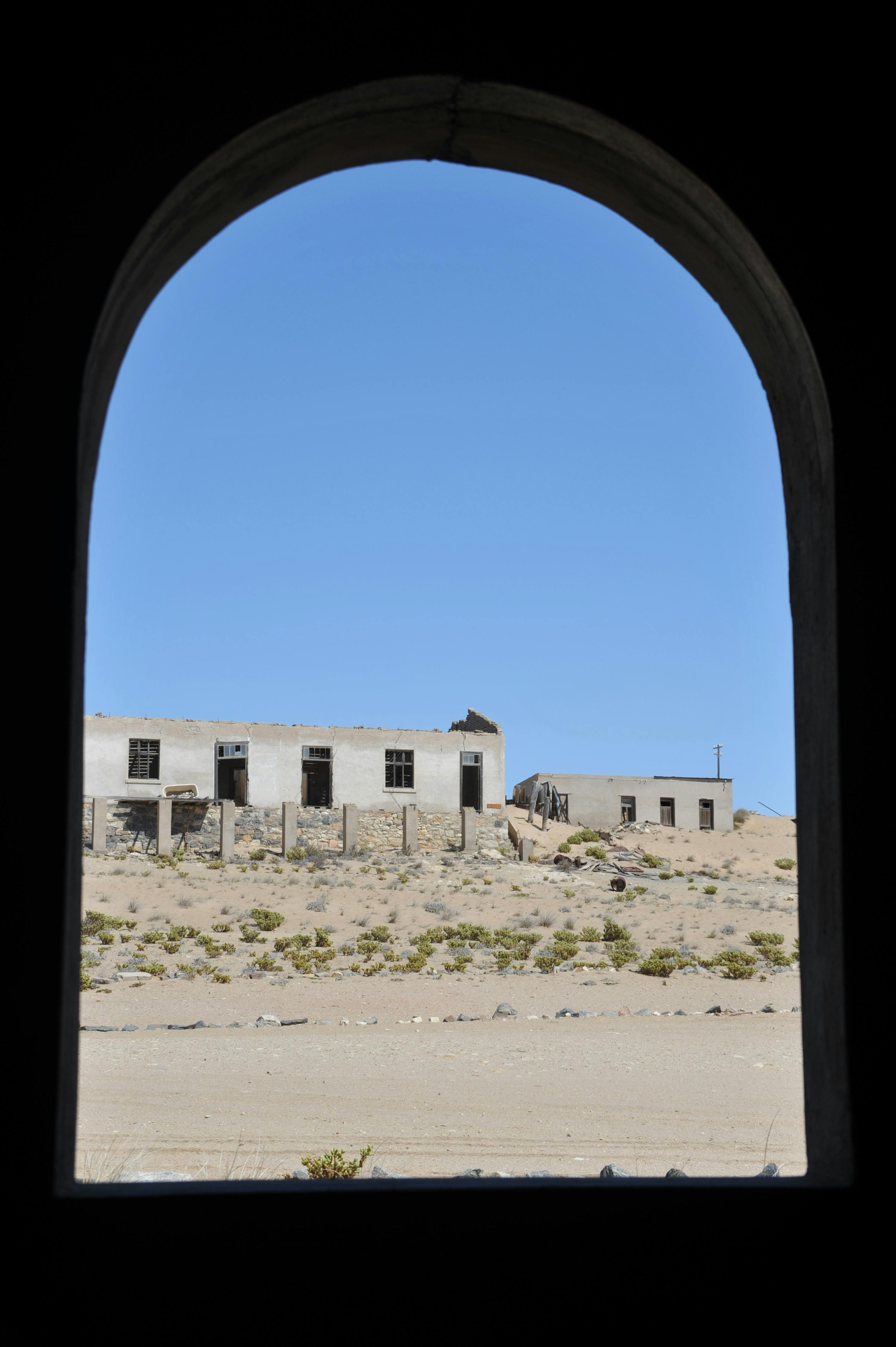 Arid Landscape Seen through an Arch · Free Stock Photo