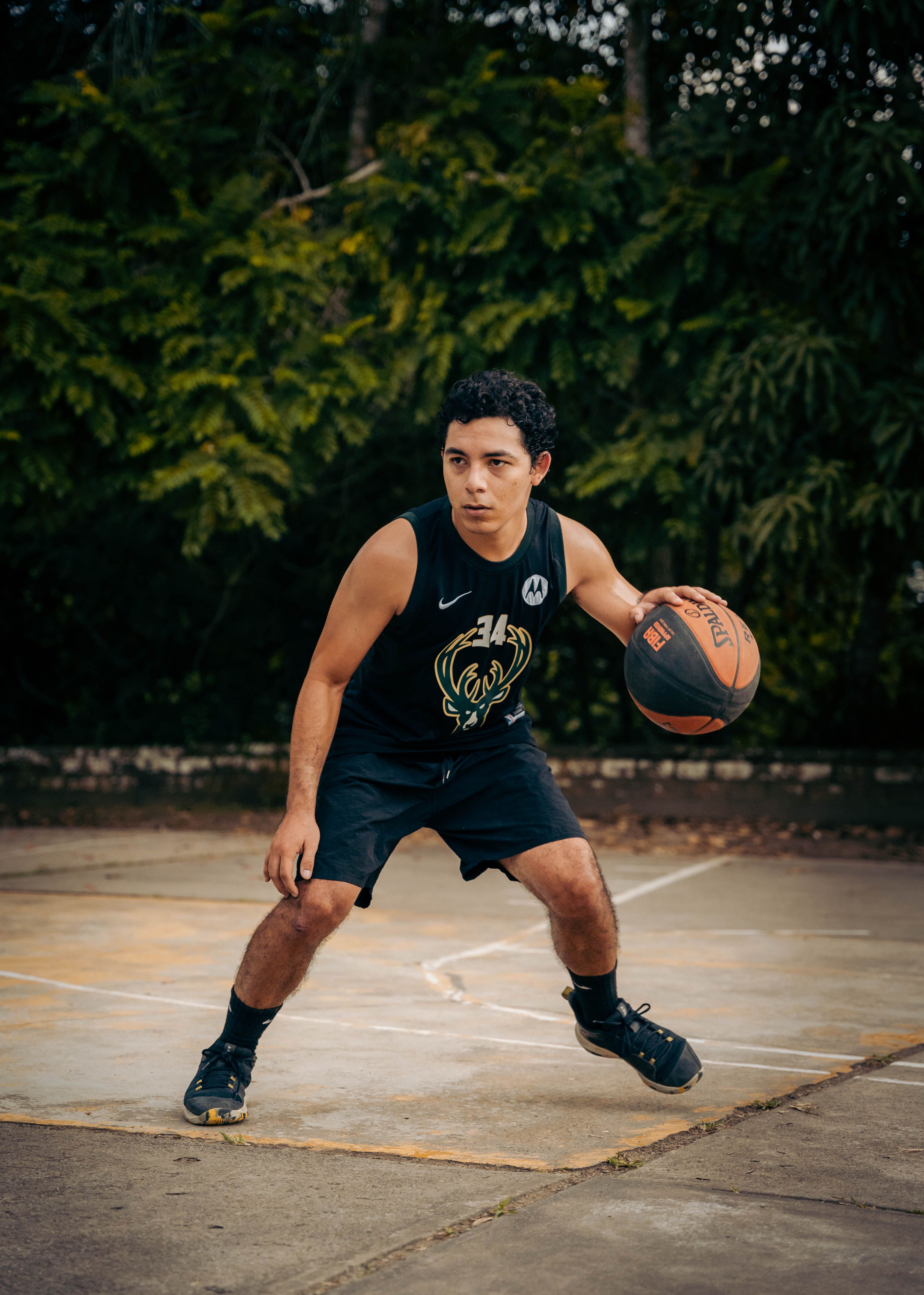 Young Man Sitting on the Ground at a Basketball Court · Free Stock Photo
