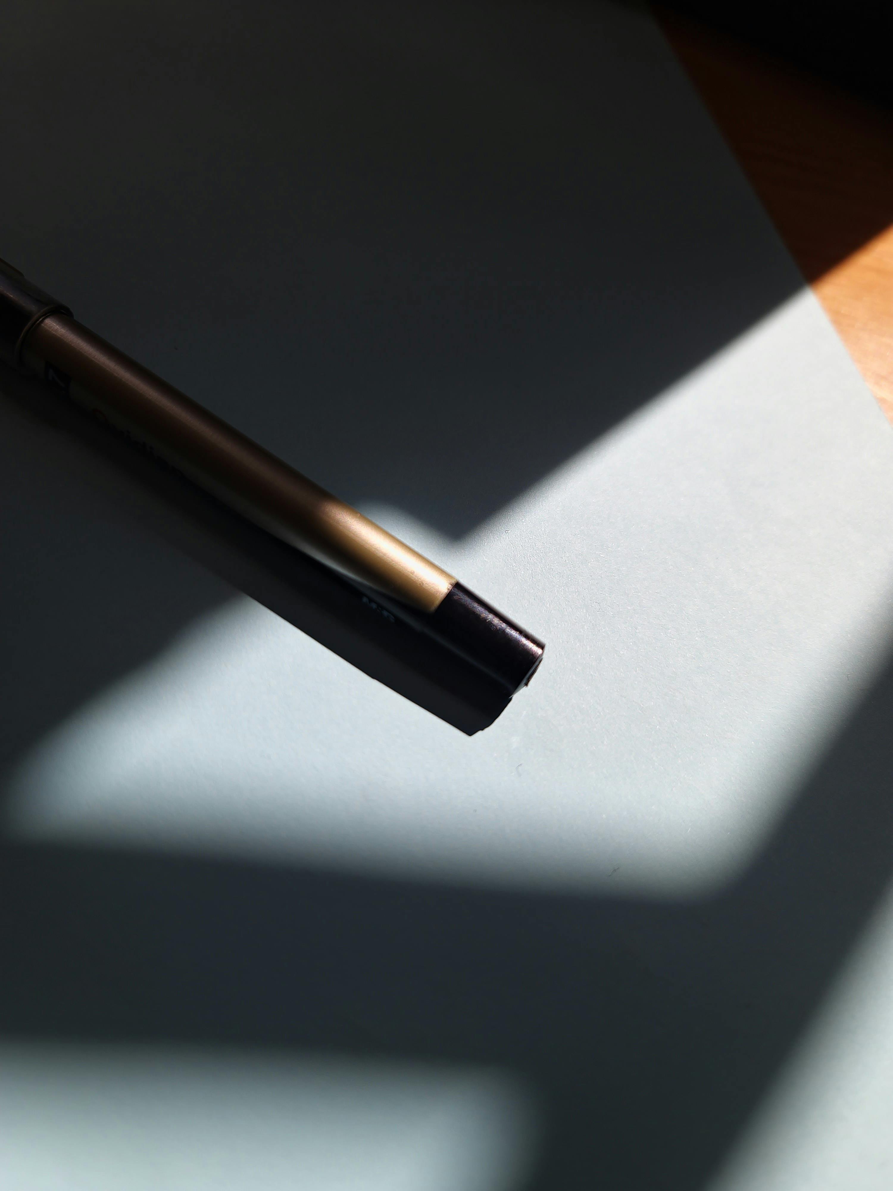 Pen on a Desk in Shadow · Free Stock Photo