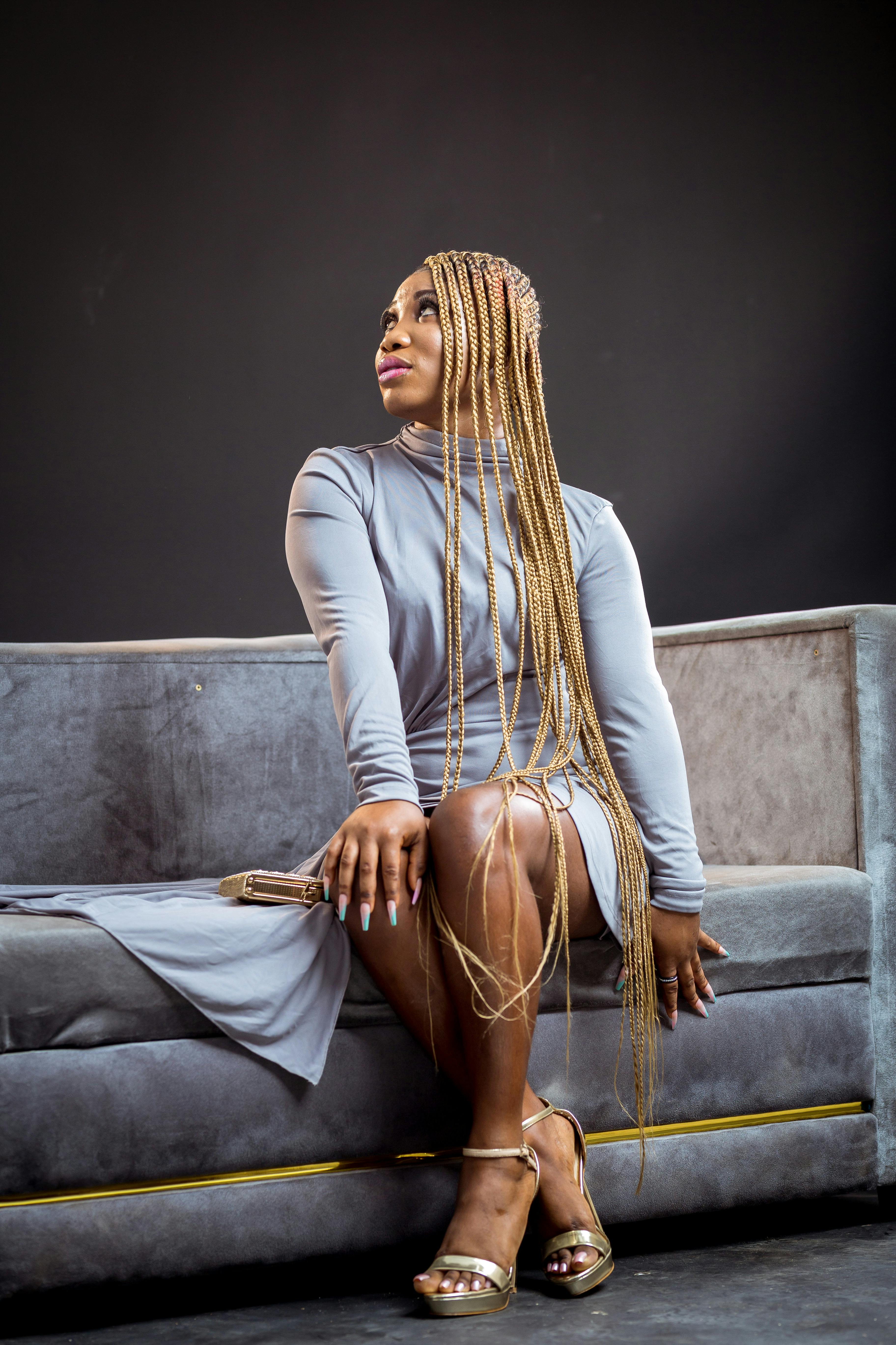 Blonde Woman Sitting on Floor with Arms Raised · Free Stock Photo