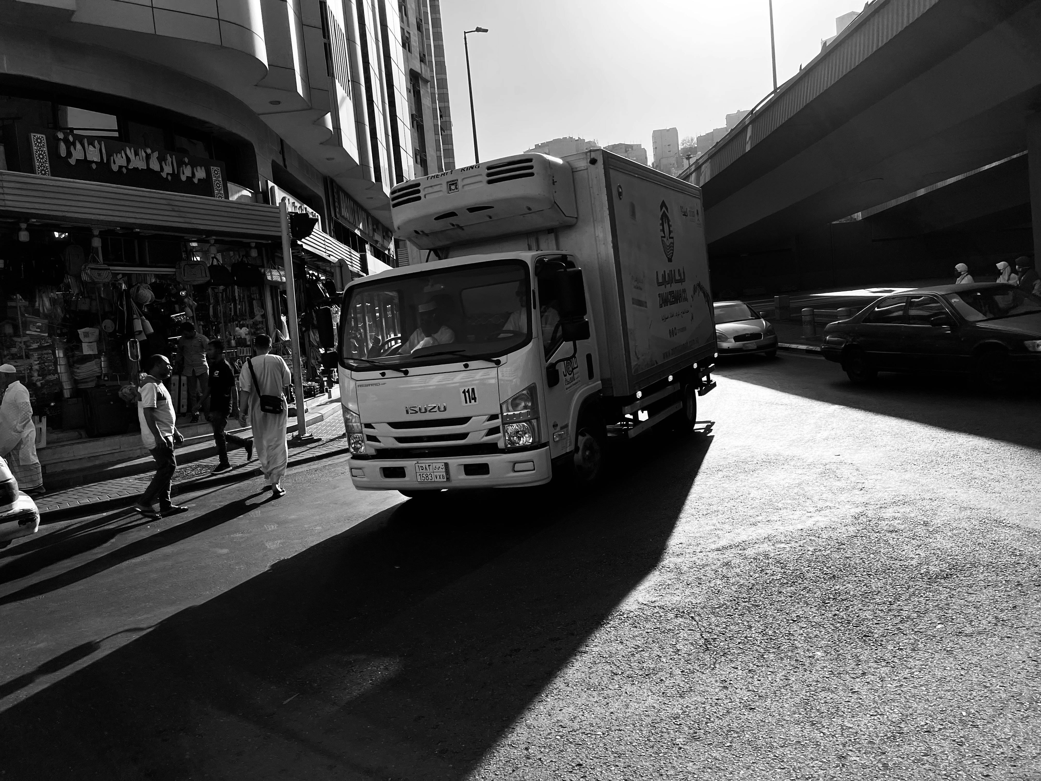 Truck Riding on a Street in Black and White · Free Stock Photo