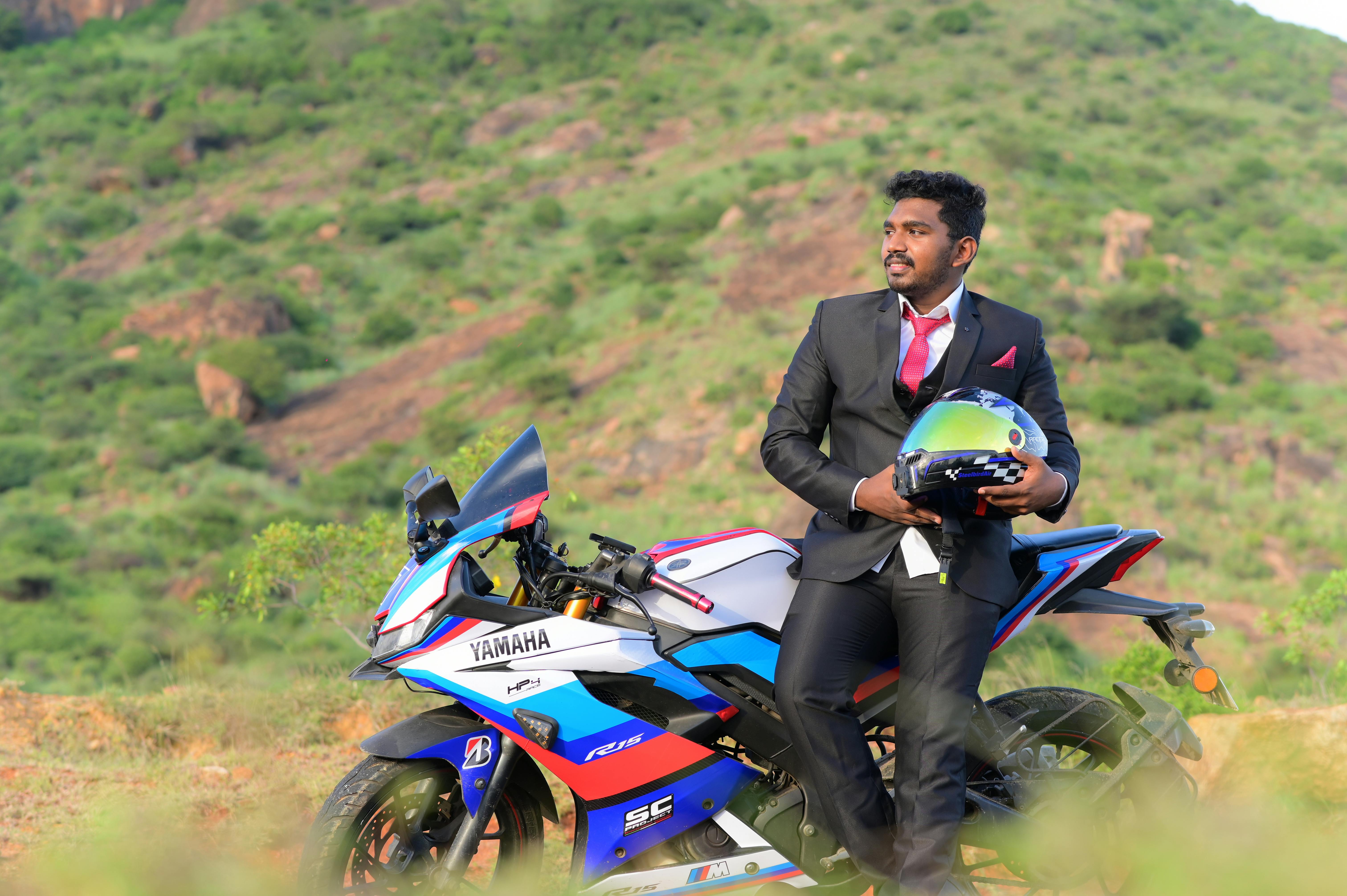 Man in Black Suit and Tie Standing with Helmet Next to Yamaha YZF-R15 ...