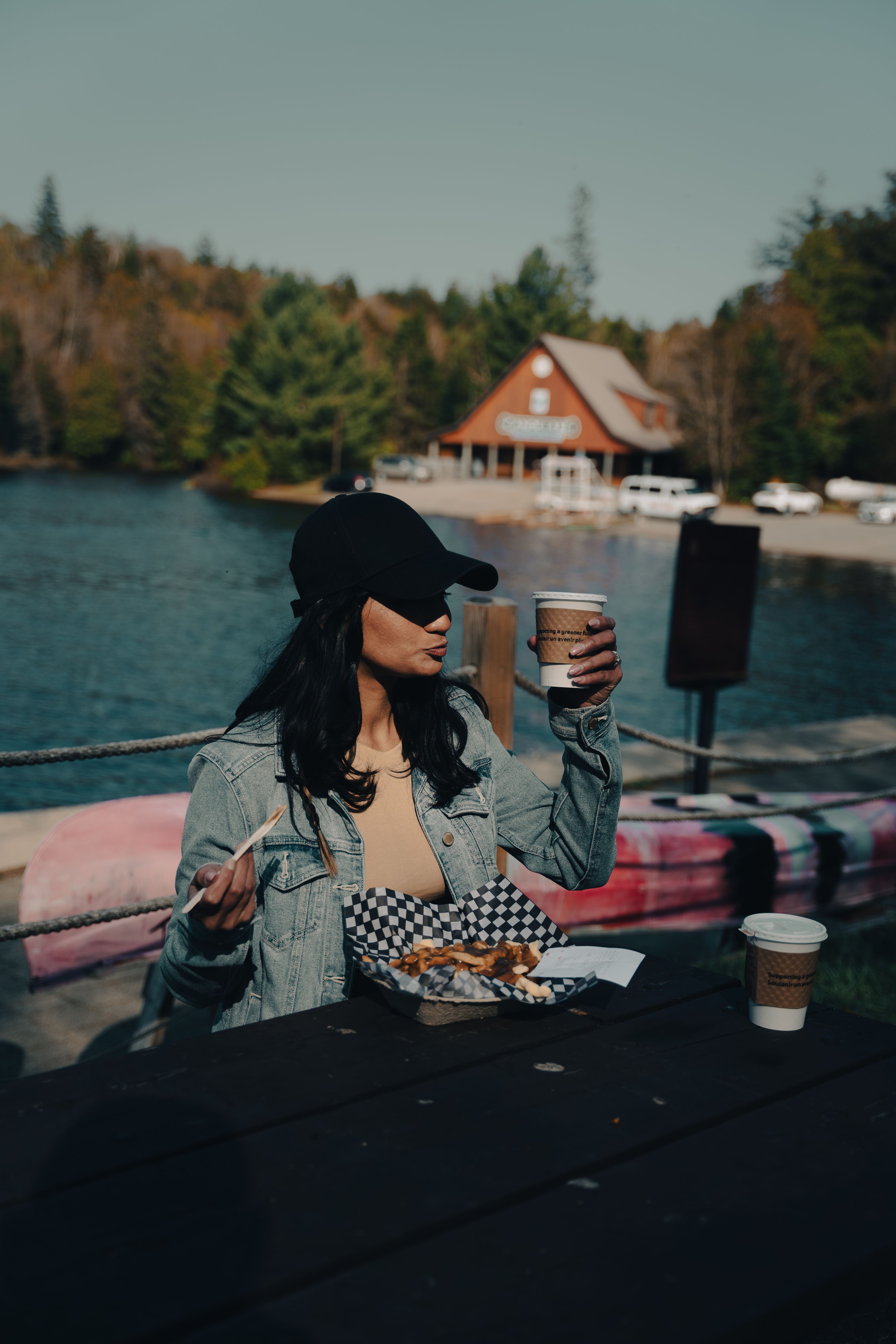 Woman in Jean Jacket Sitting by Table · Free Stock Photo