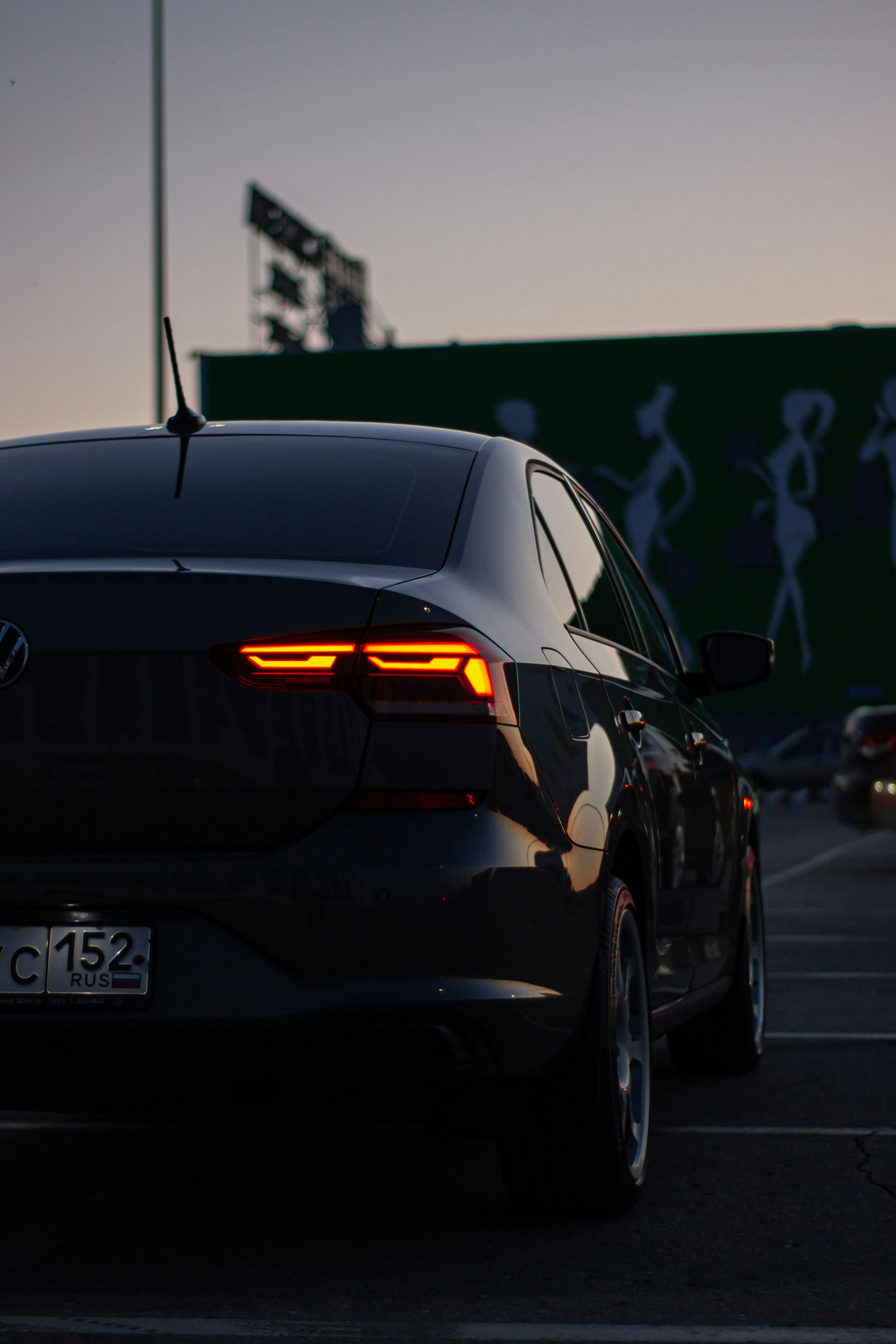 Rear View of a Black Volkswagen Car on a Parking Lot · Free Stock Photo