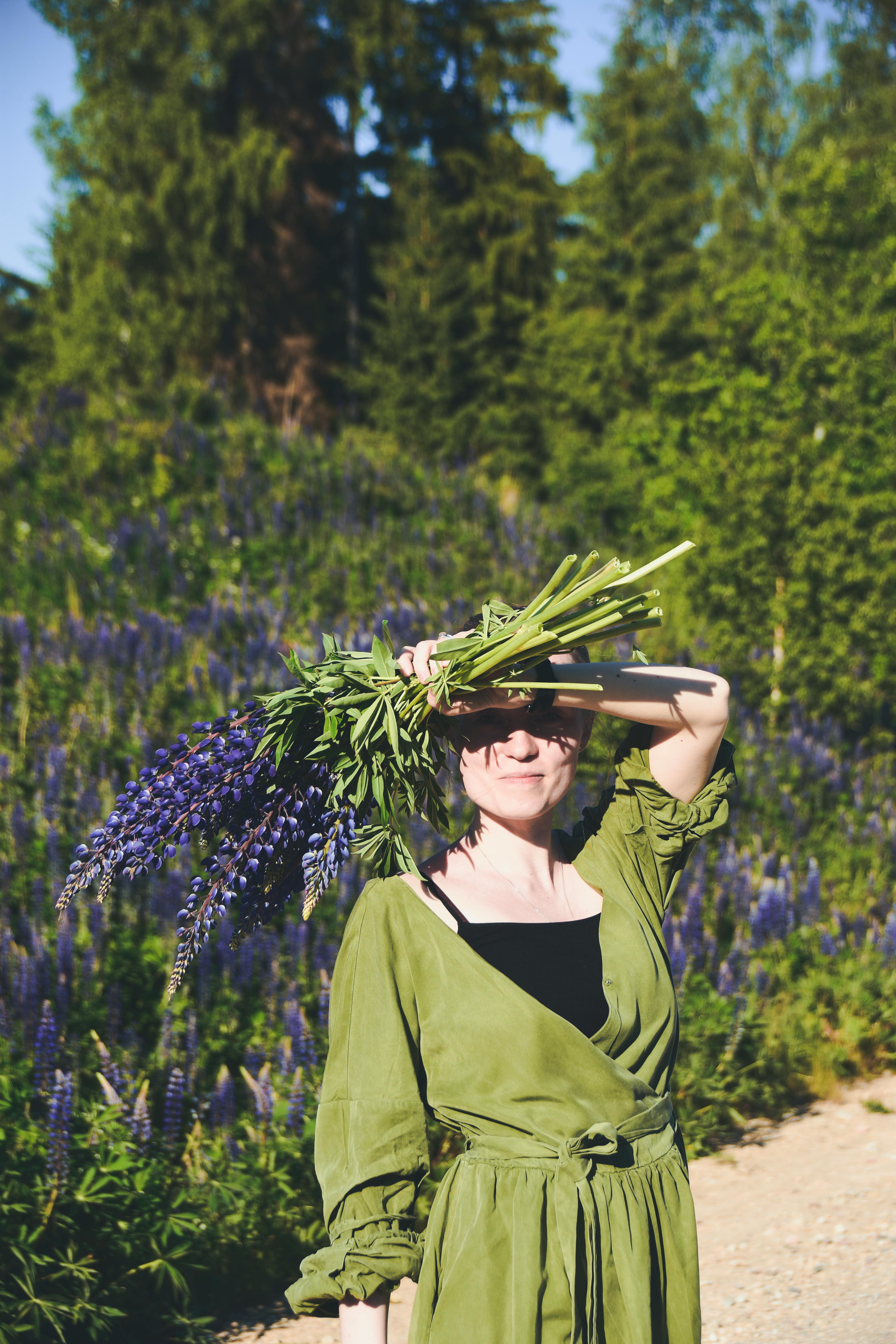 Woman in Green Clothes and with Flowers · Free Stock Photo