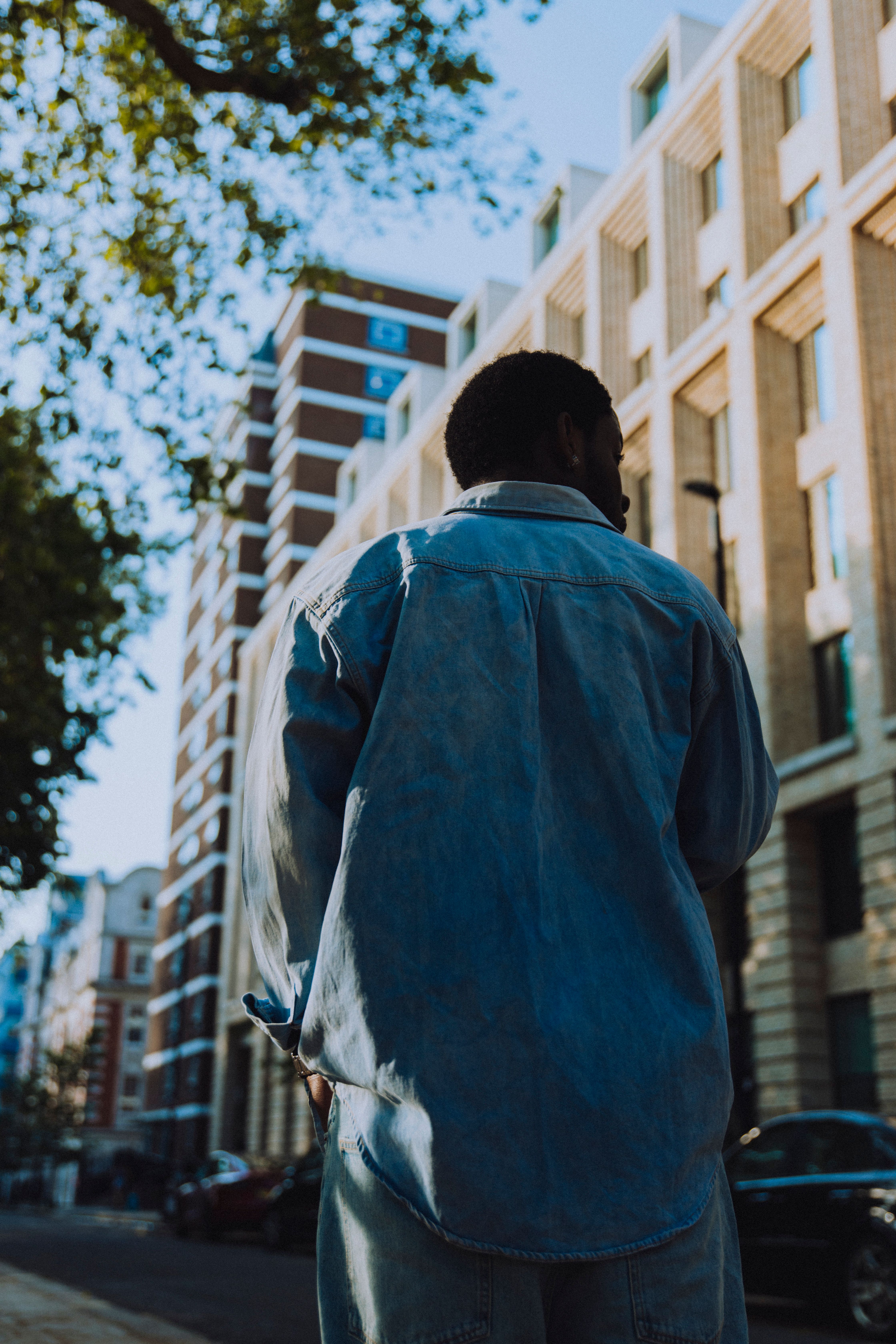 Back View of a Man Standing on the Street in City · Free Stock Photo