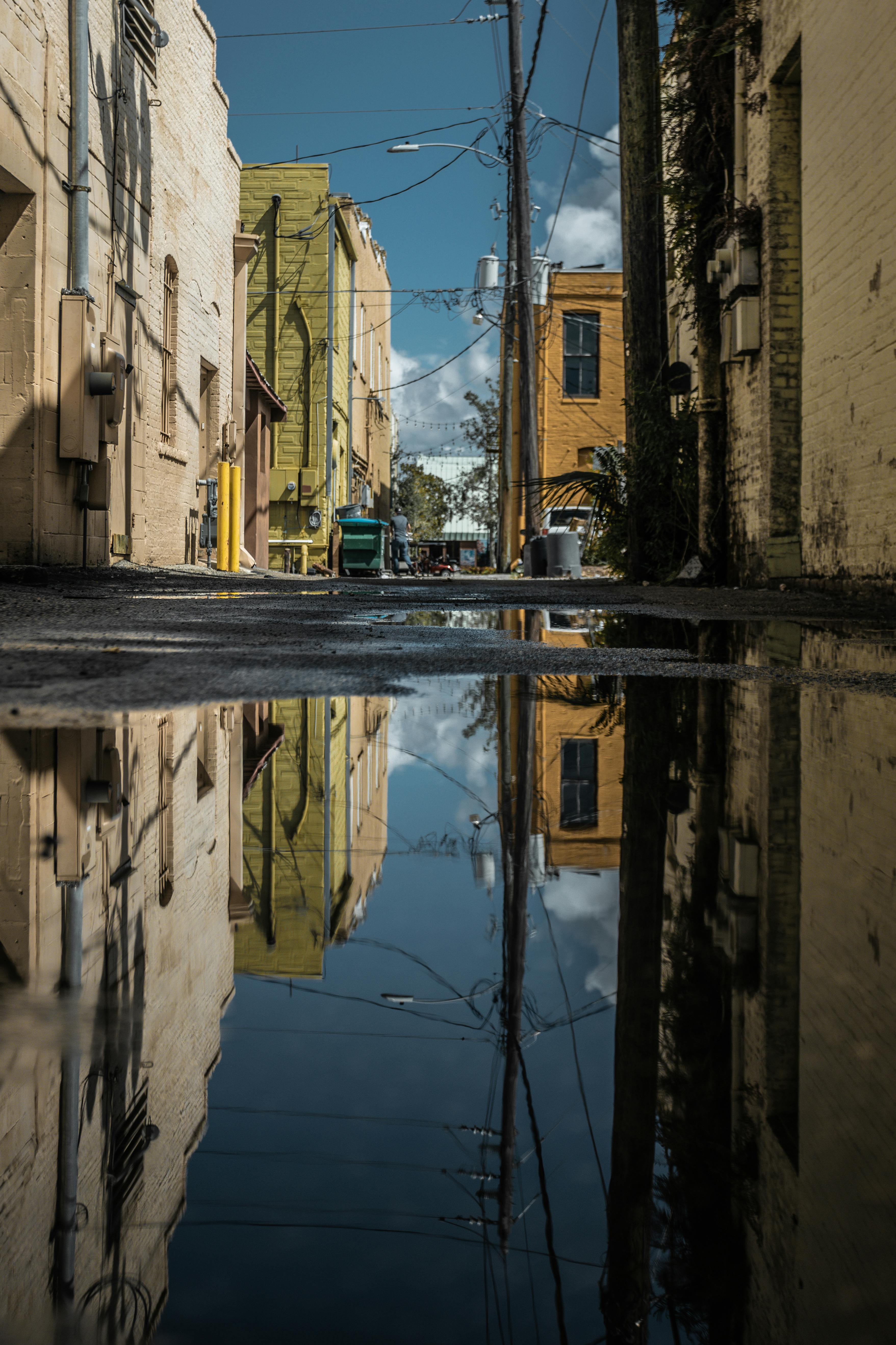 Puddles on the Street Reflecting the Houses · Free Stock Photo