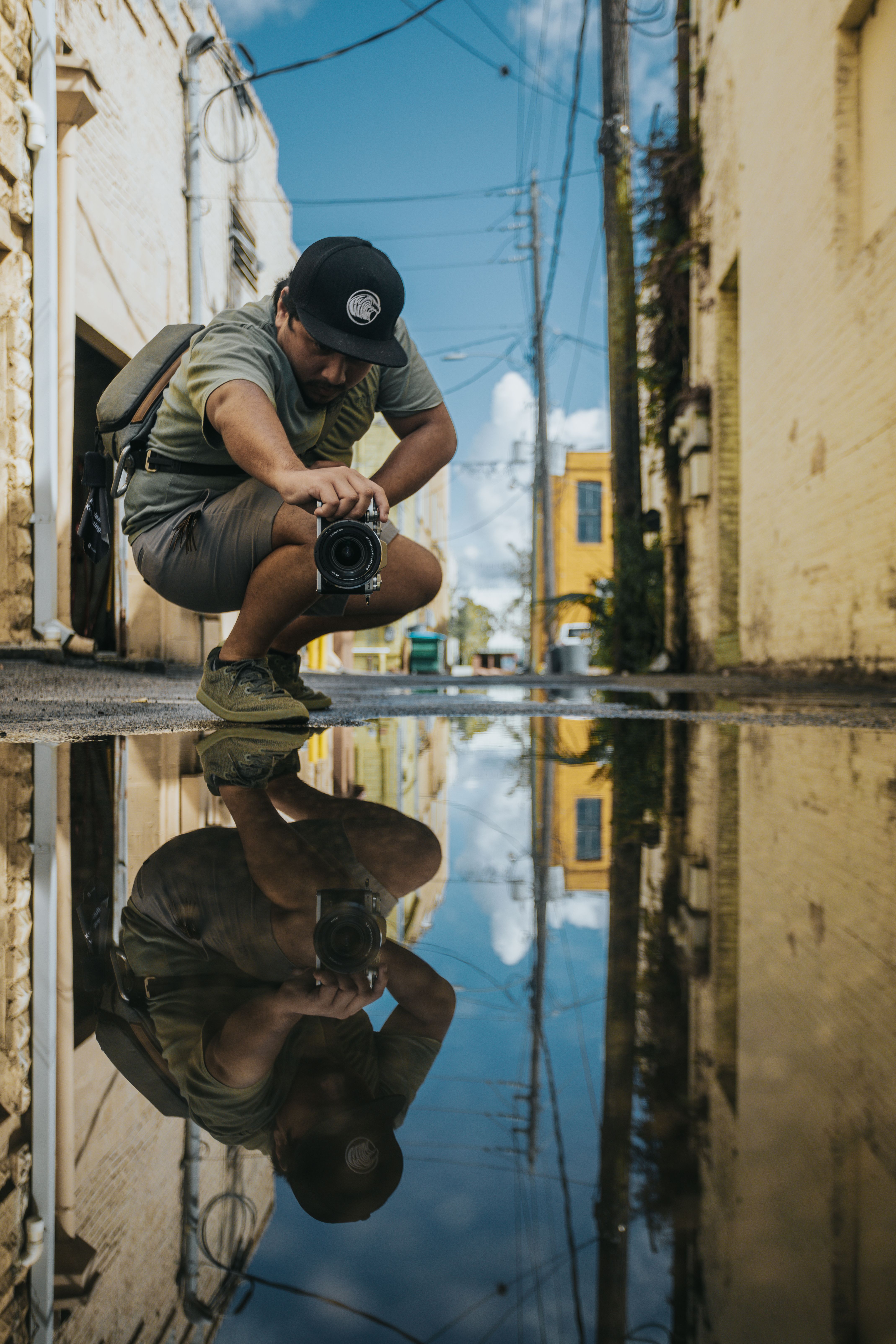 Man Squatting near Puddle and Taking Pictures with Camera · Free Stock ...