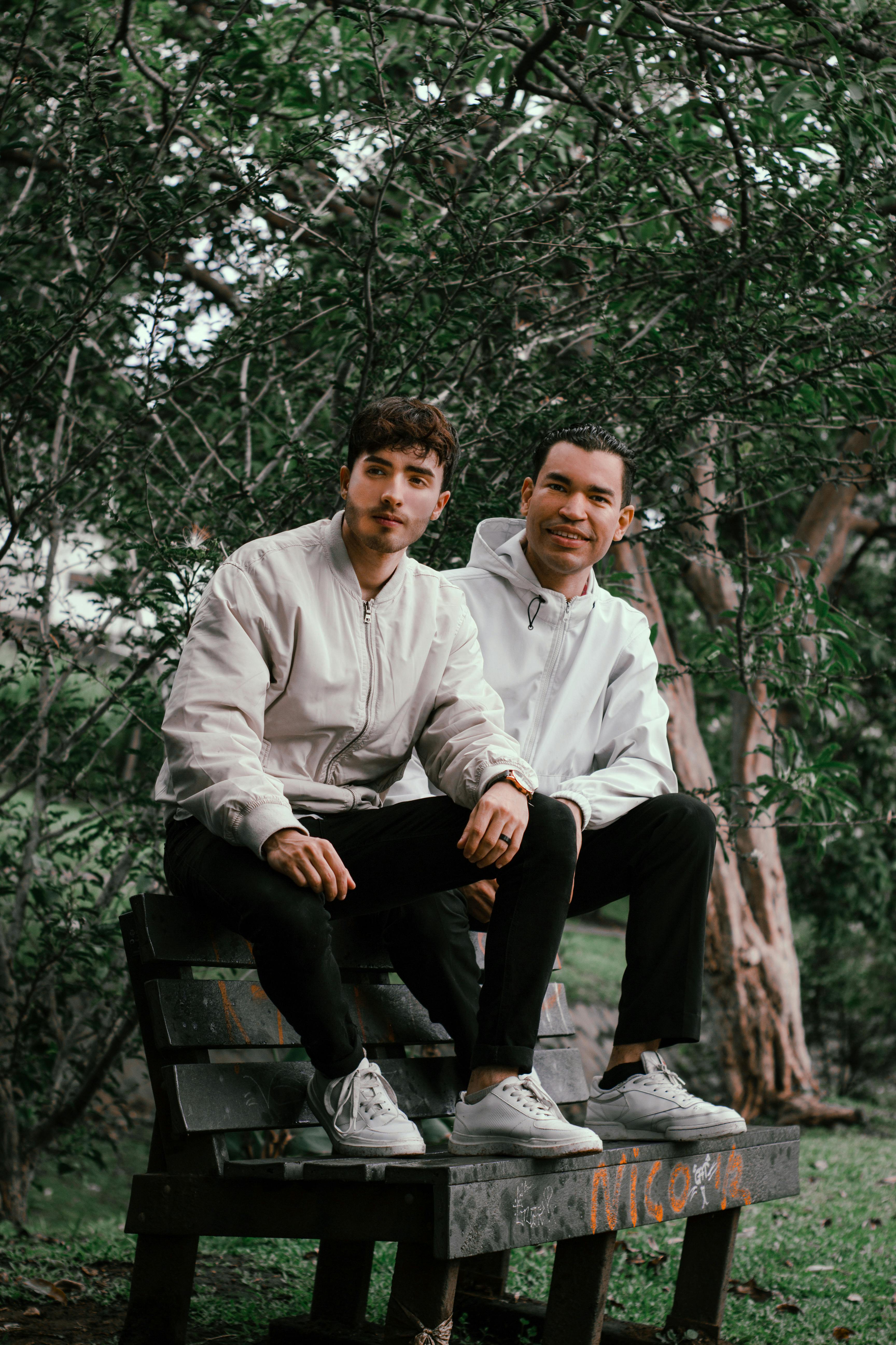 Cool Young Man Sitting on a Bench · Free Stock Photo