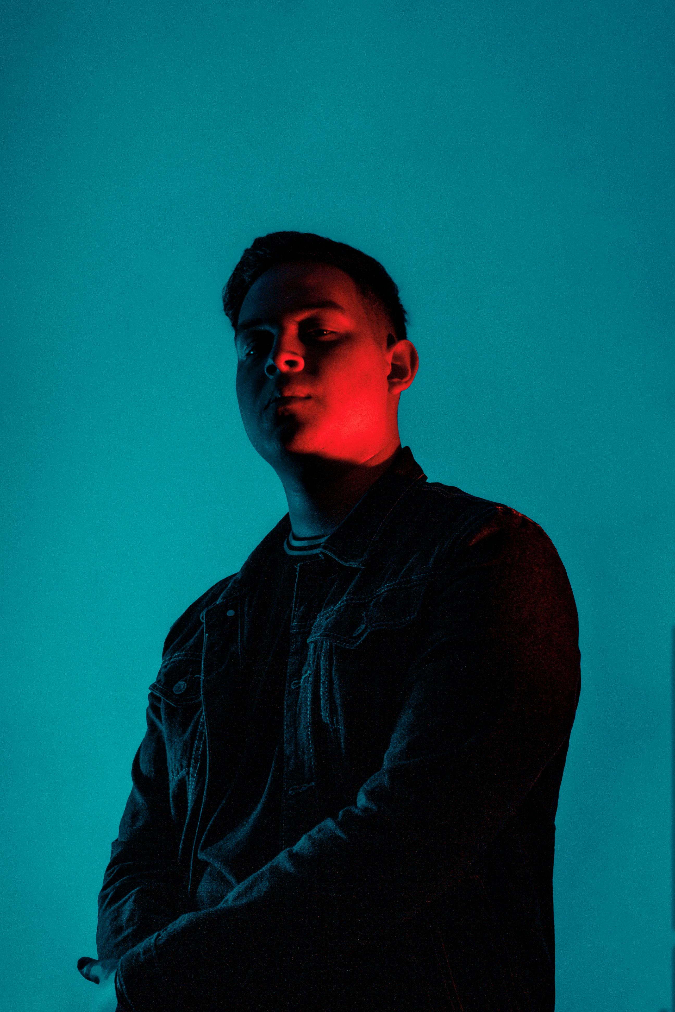 Man under Red Light on Blue Back · Free Stock Photo