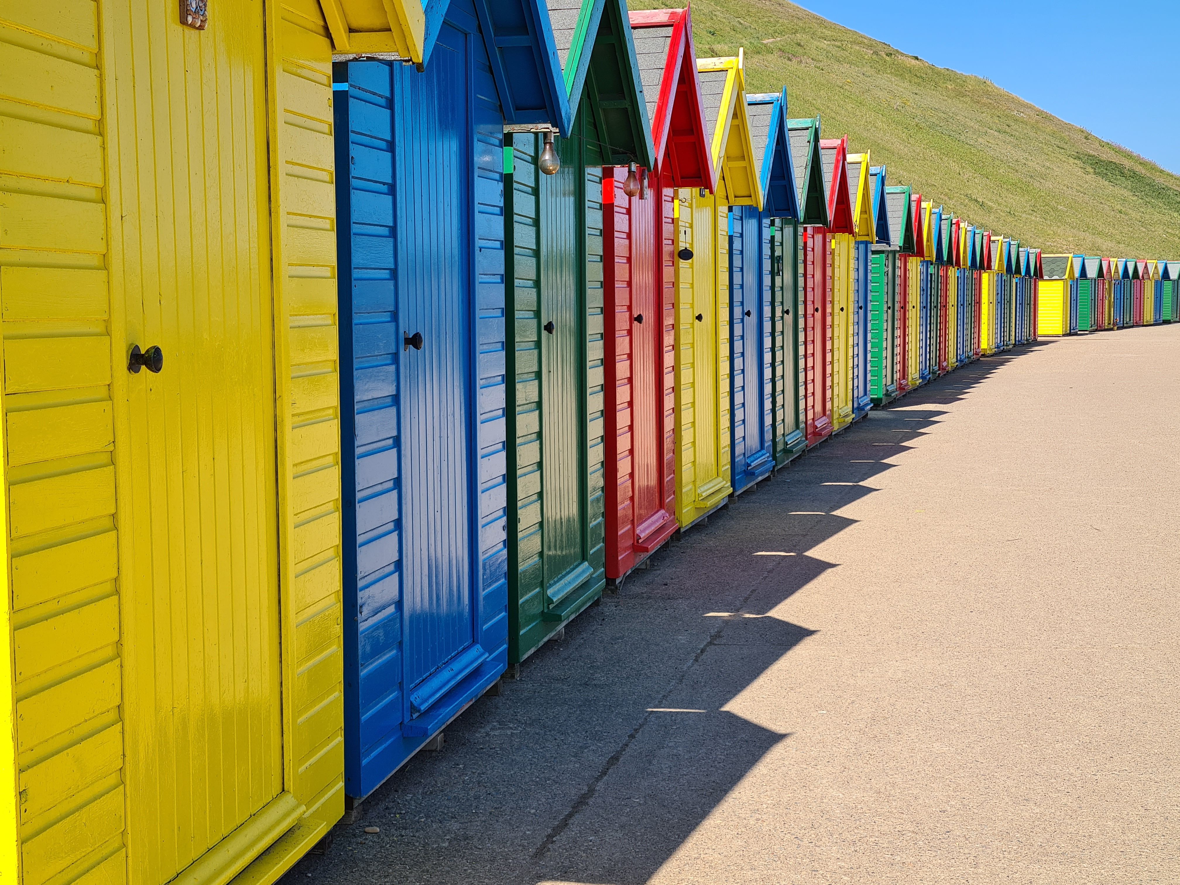 Multi Colored Cabin by Road · Free Stock Photo