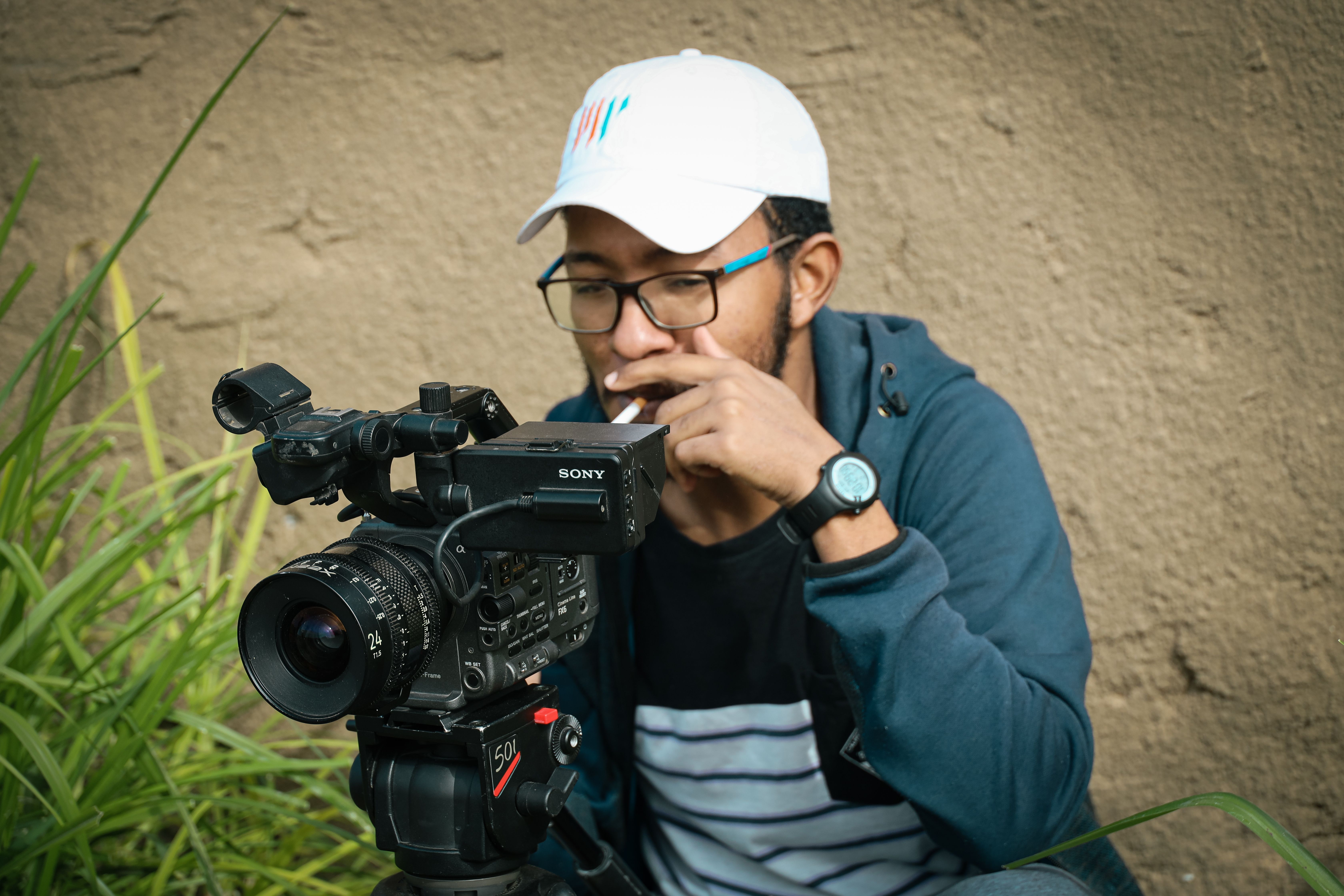 Smoking Photographer Sitting with Camera · Free Stock Photo